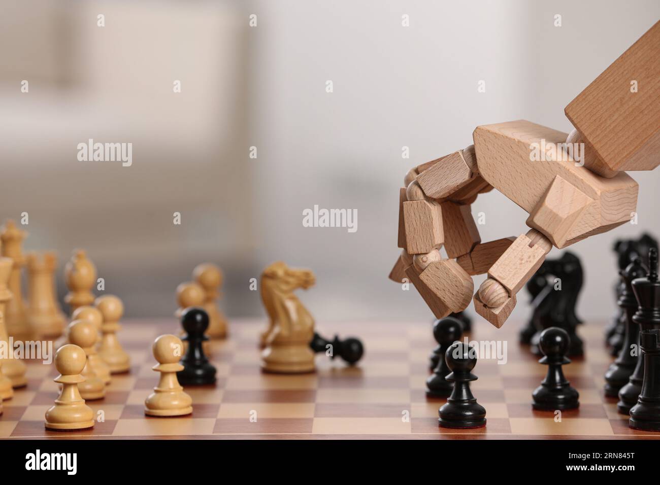 Wooden hand representing artificial intelligence. Robot moving chess ...