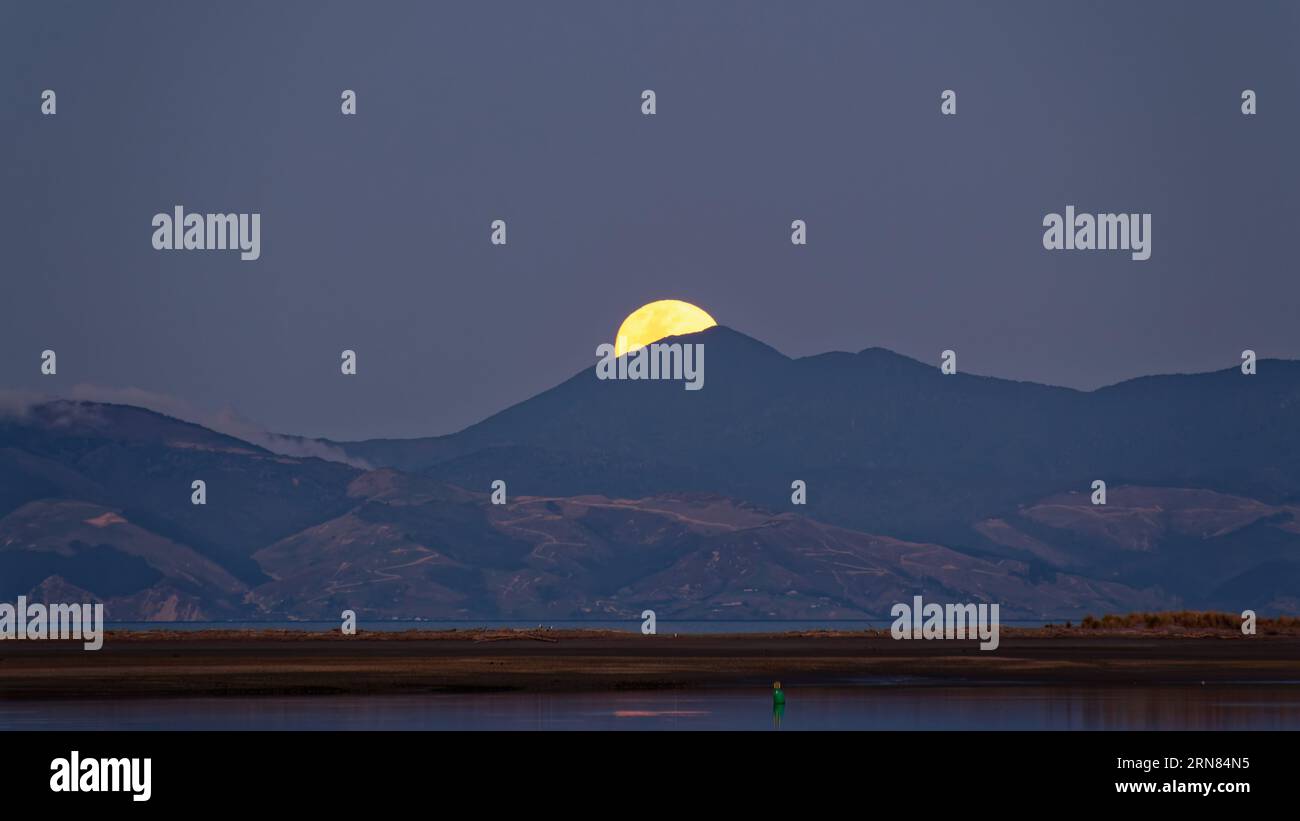 A super blue moon rises over the hills of Nelson in New Zealand. It is ...