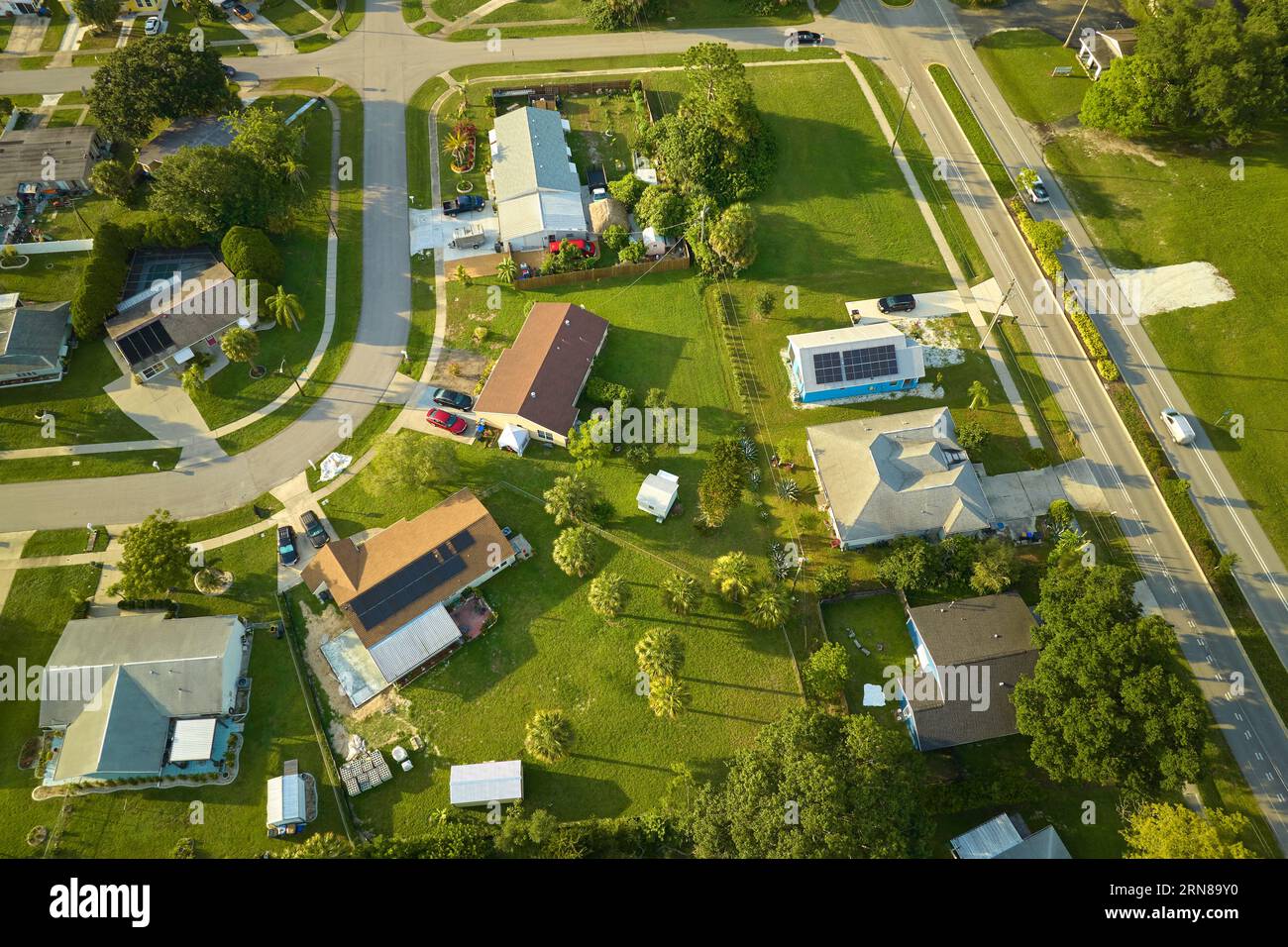 Aerial landscape view of suburban private houses between green palm ...