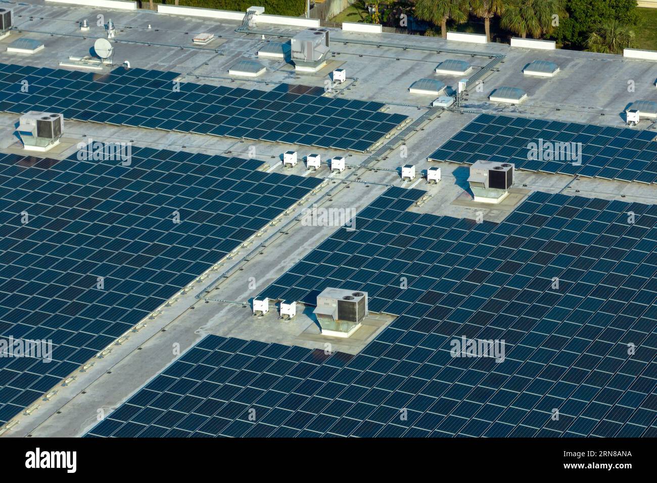 Aerial view of blue photovoltaic solar panels mounted on industrial ...