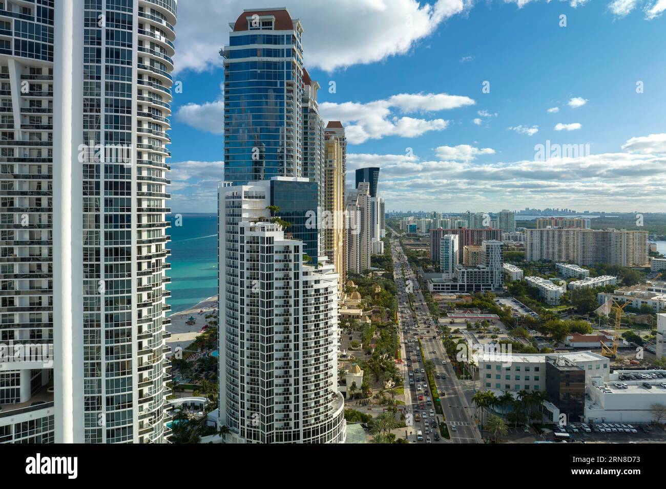 Aerial view of Sunny Isles Beach city with congested street traffic and ...