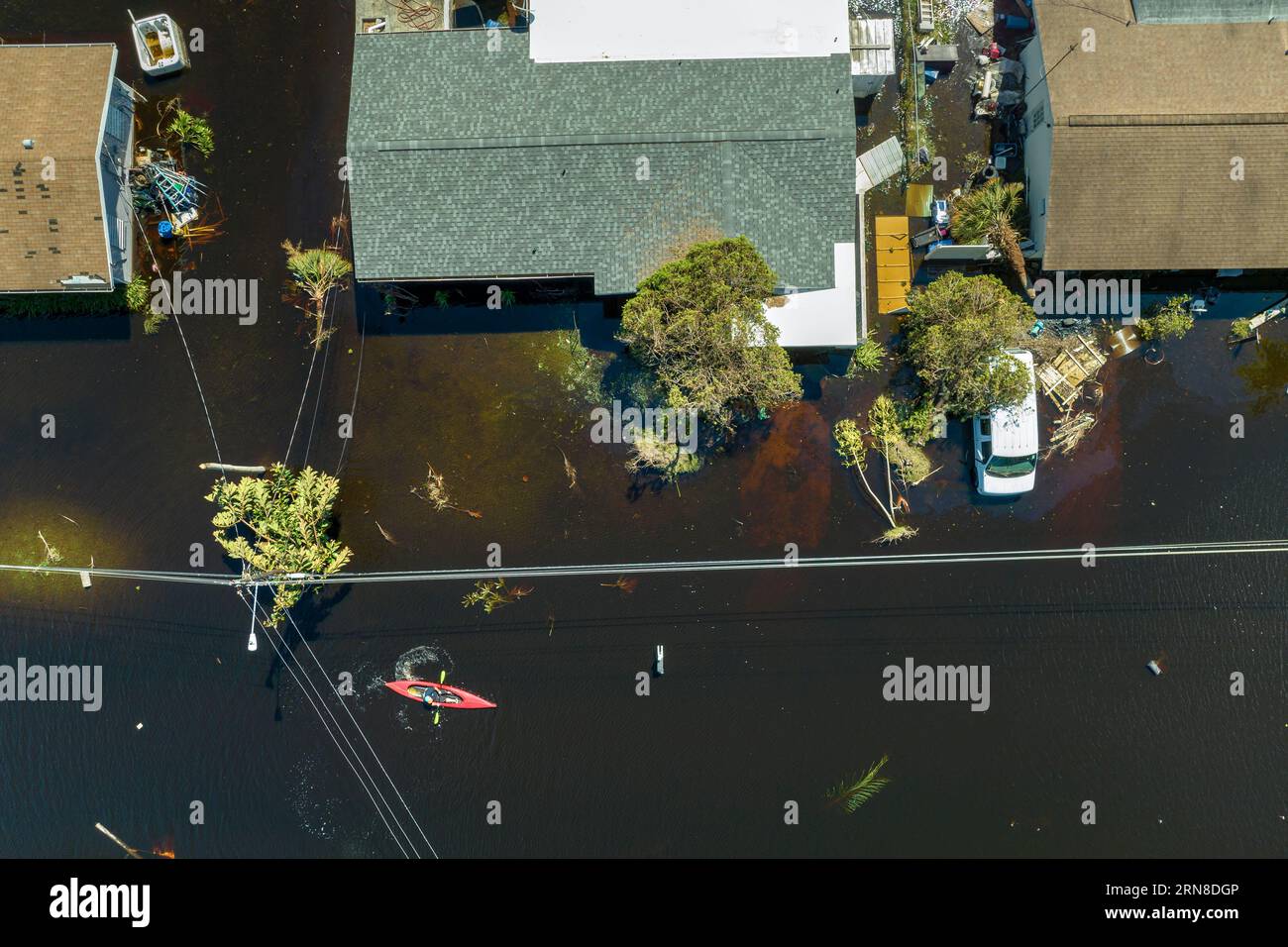 Aftermath of flooding natural disaster. Kayak boat floating on flooded ...