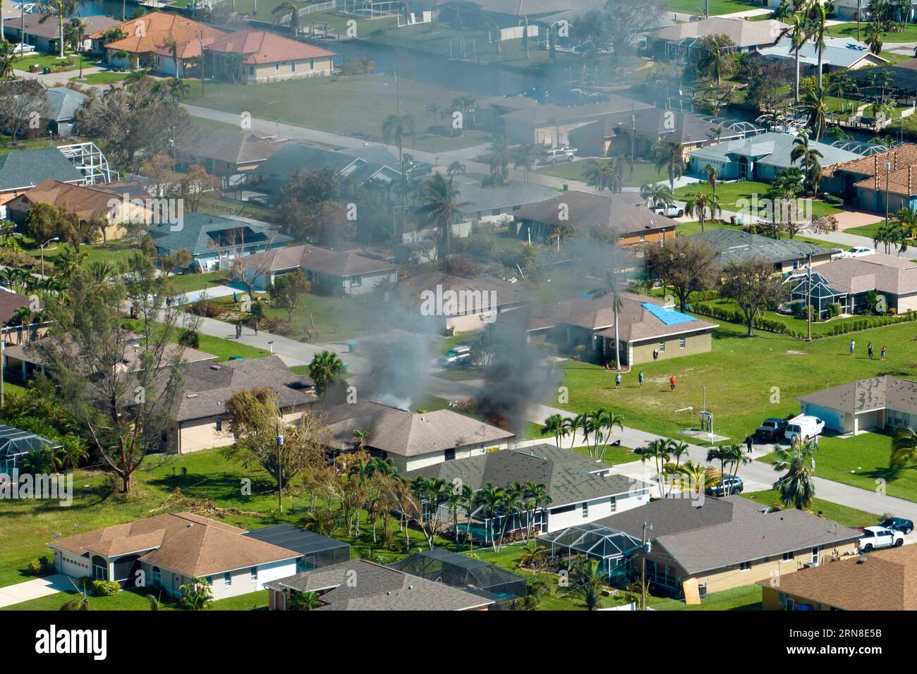 Burning residential house on fire with smoke and flames and ...