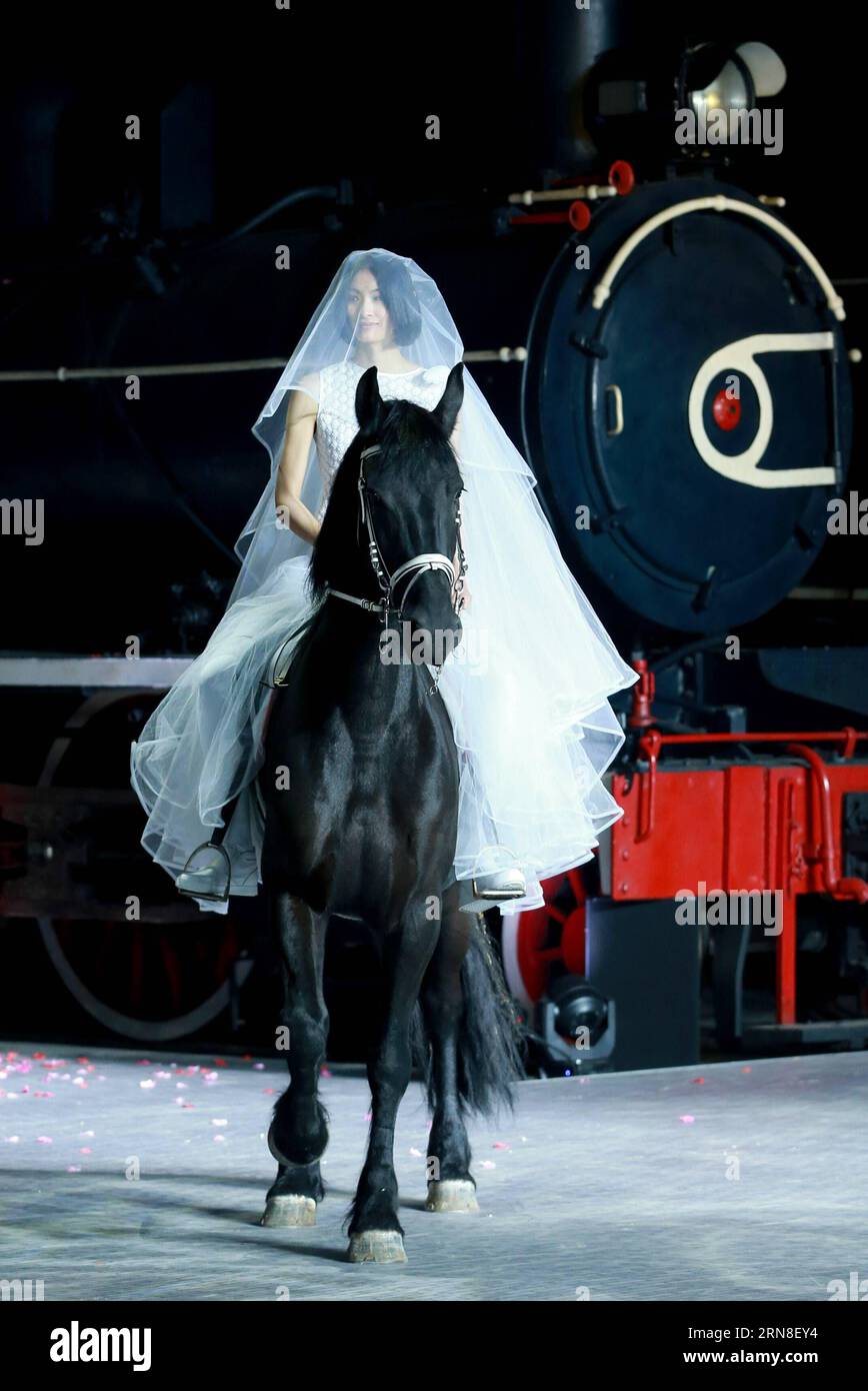 A model rides a horse to present the creation from Pierre Cardin 2016 ...