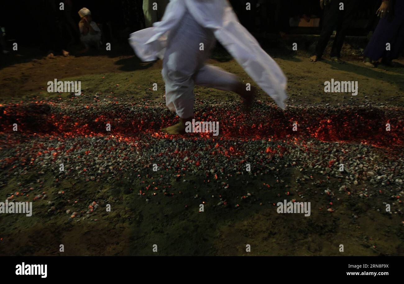 A Muslim child runs on burning coal fire during a ceremony ahead of ...