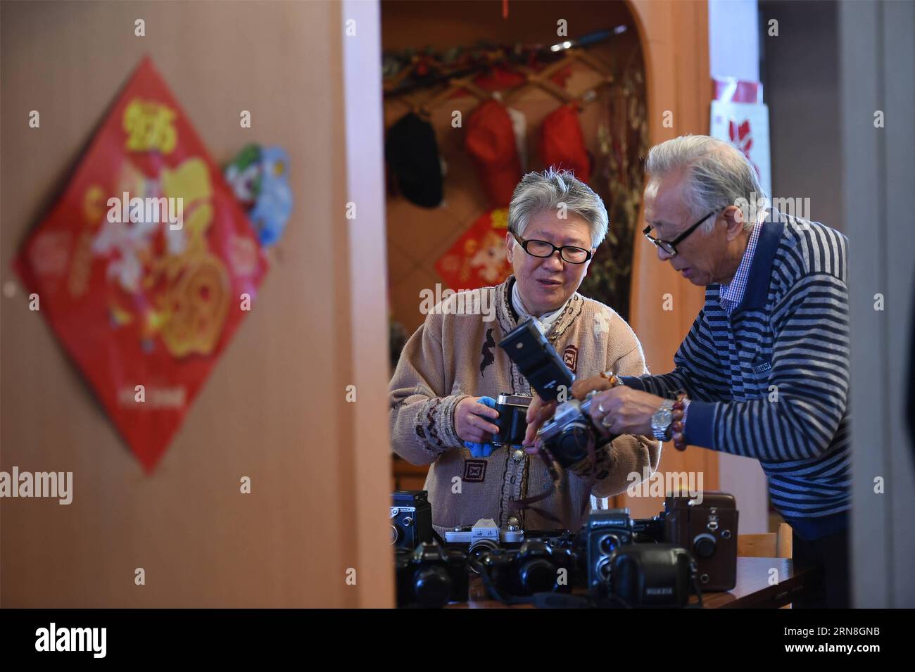 Li Chang, 81, and his wife Zhang Guiqin wipe cameras at their home in ...