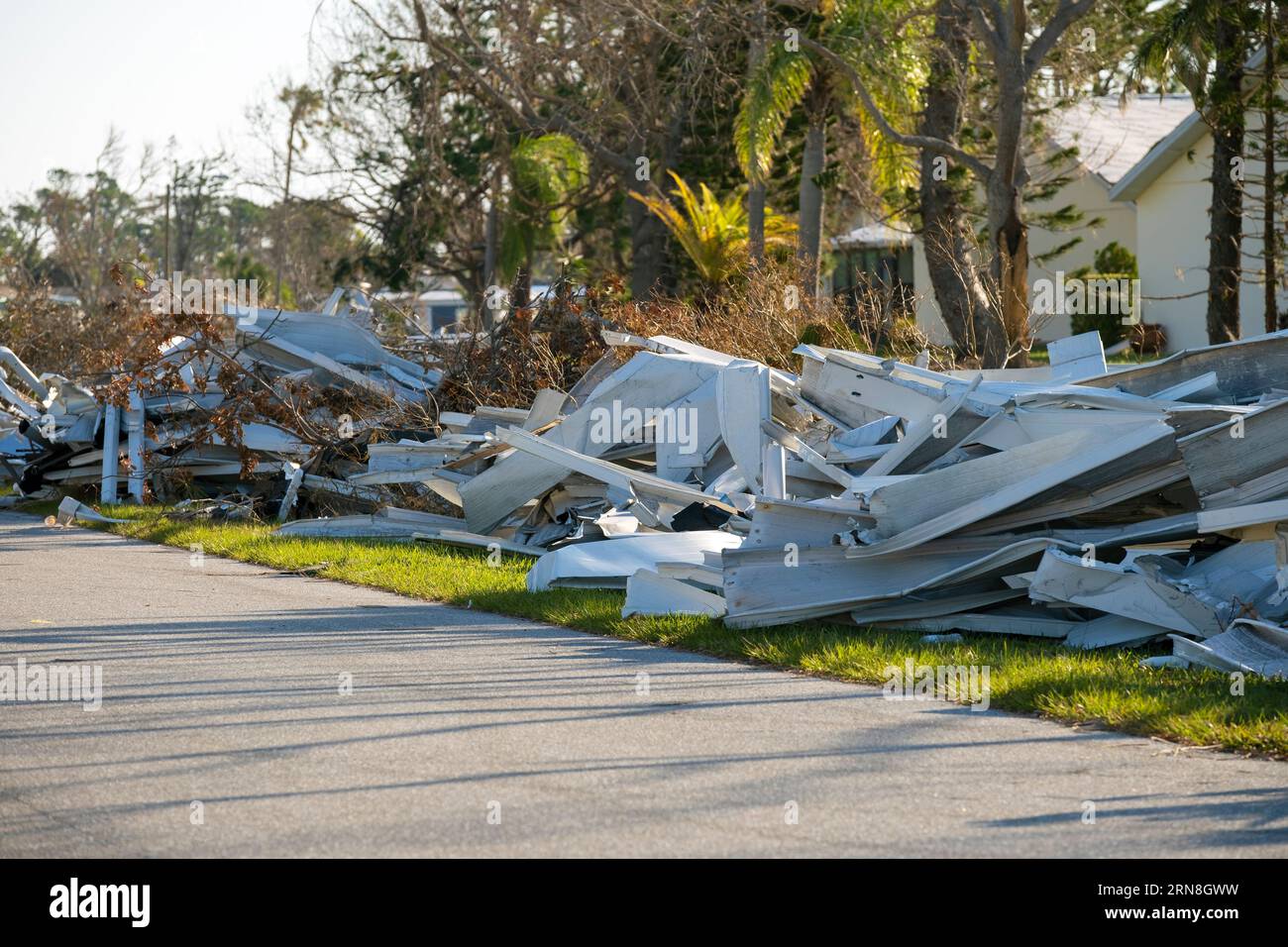 Heaps of debris rubbish on street side near severely damaged by ...