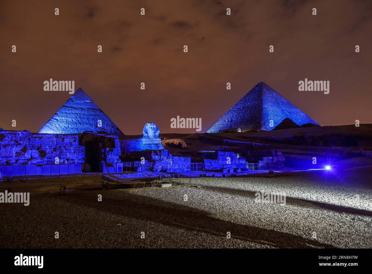 The Great Pyramids of Giza is lit up blue in Giza, Egypt, as part of ...