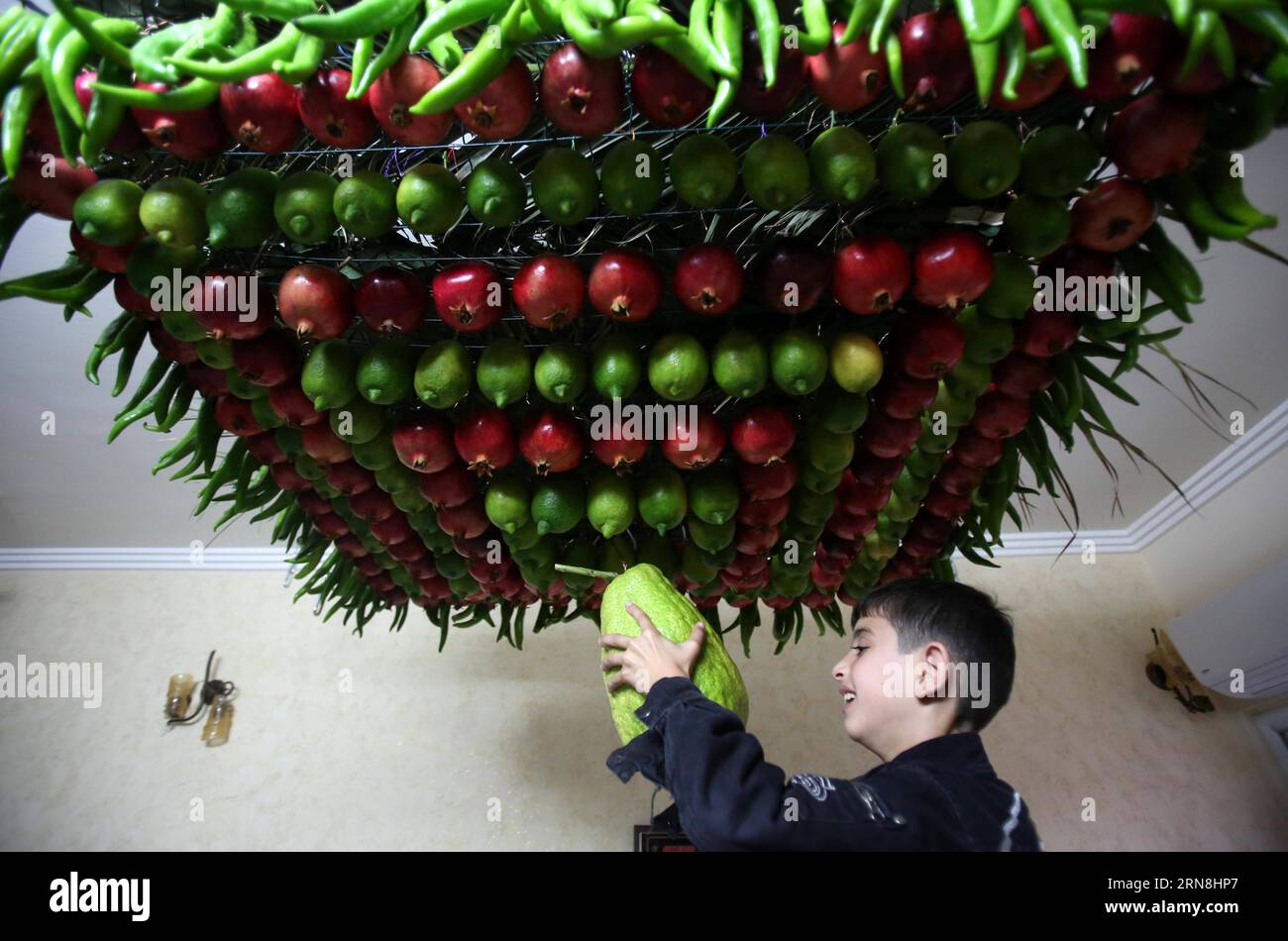 (151025) -- NABLUS, Oct. 25, 2015 -- A Samaritan boy places fruits in ...