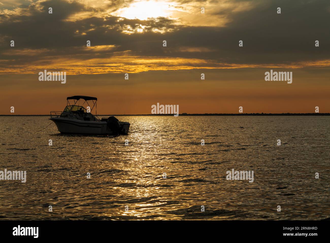 sun set and shadows of boats on a ocean in summer Stock Photo - Alamy