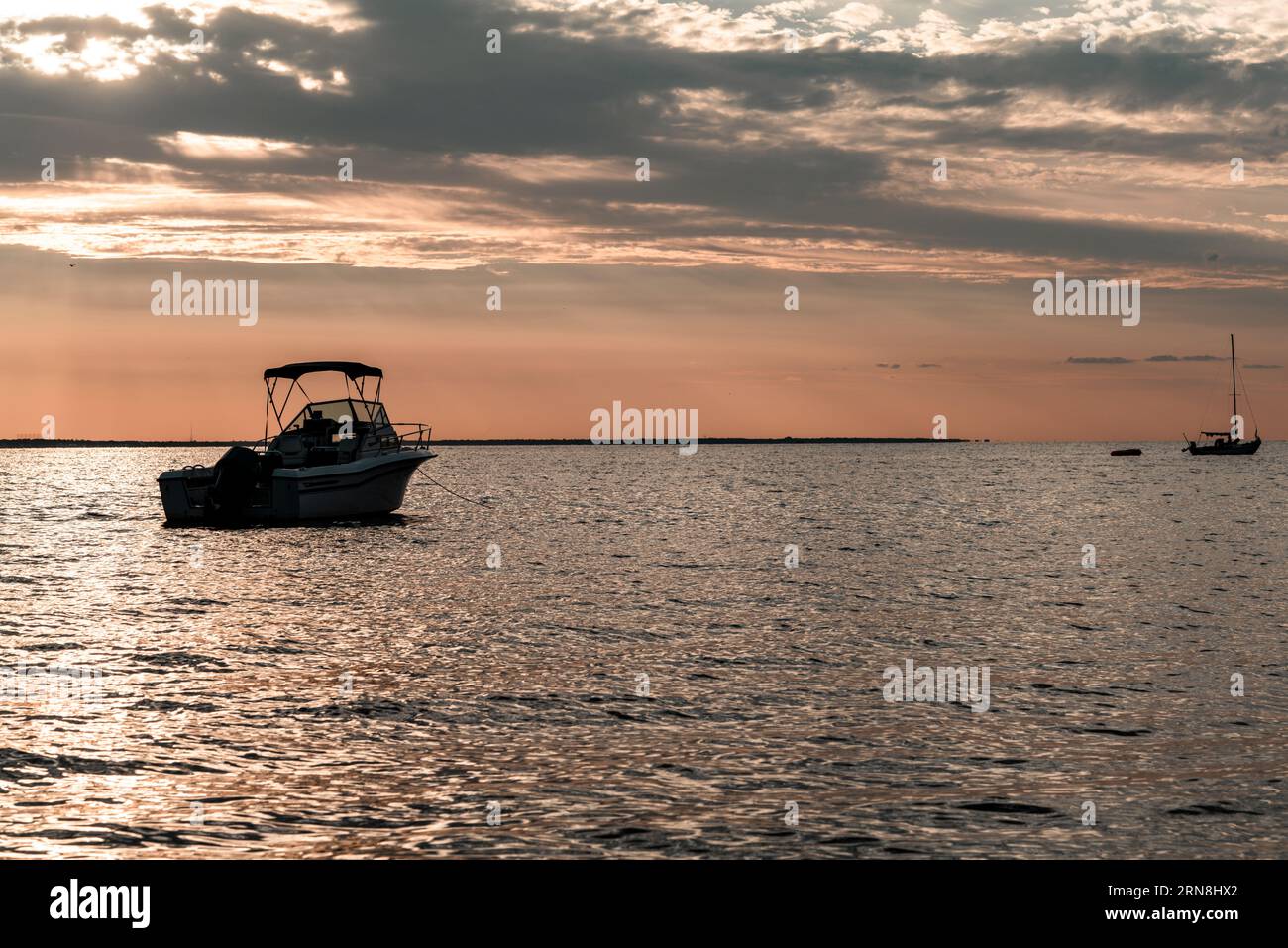 sun set and shadows of boats on a ocean in summer Stock Photo - Alamy