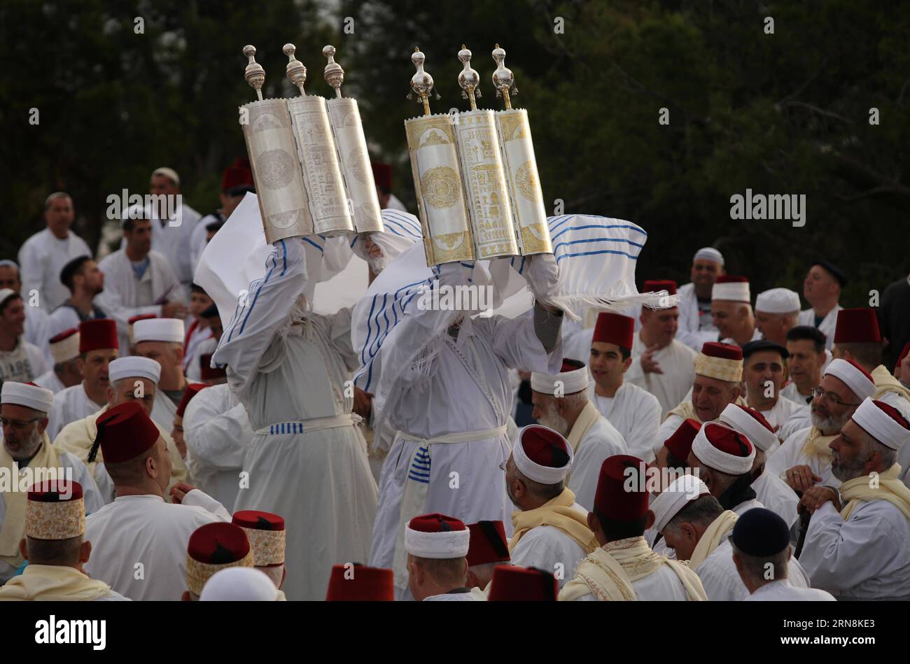 Priests hold up Torah scrolls during a traditional ceremony celebrating ...