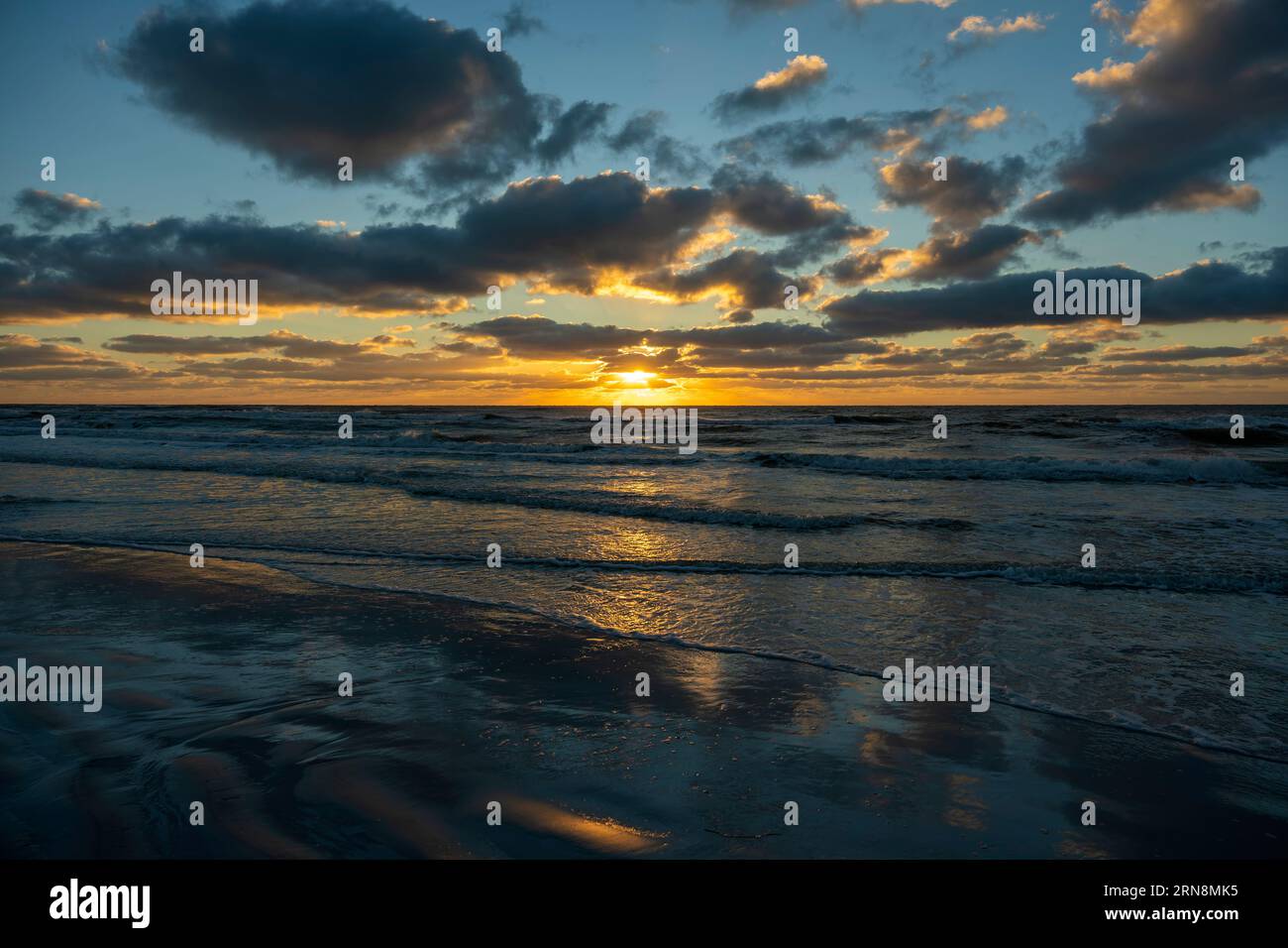 Ocean sunset landscape with soft evening sea water waves crushing on ...