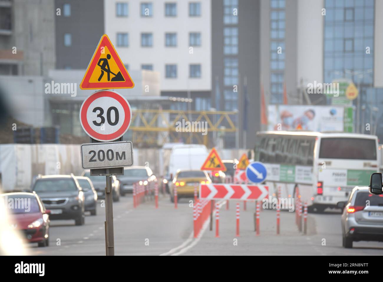 Roadworks warning traffic signs of construction work on city street and ...