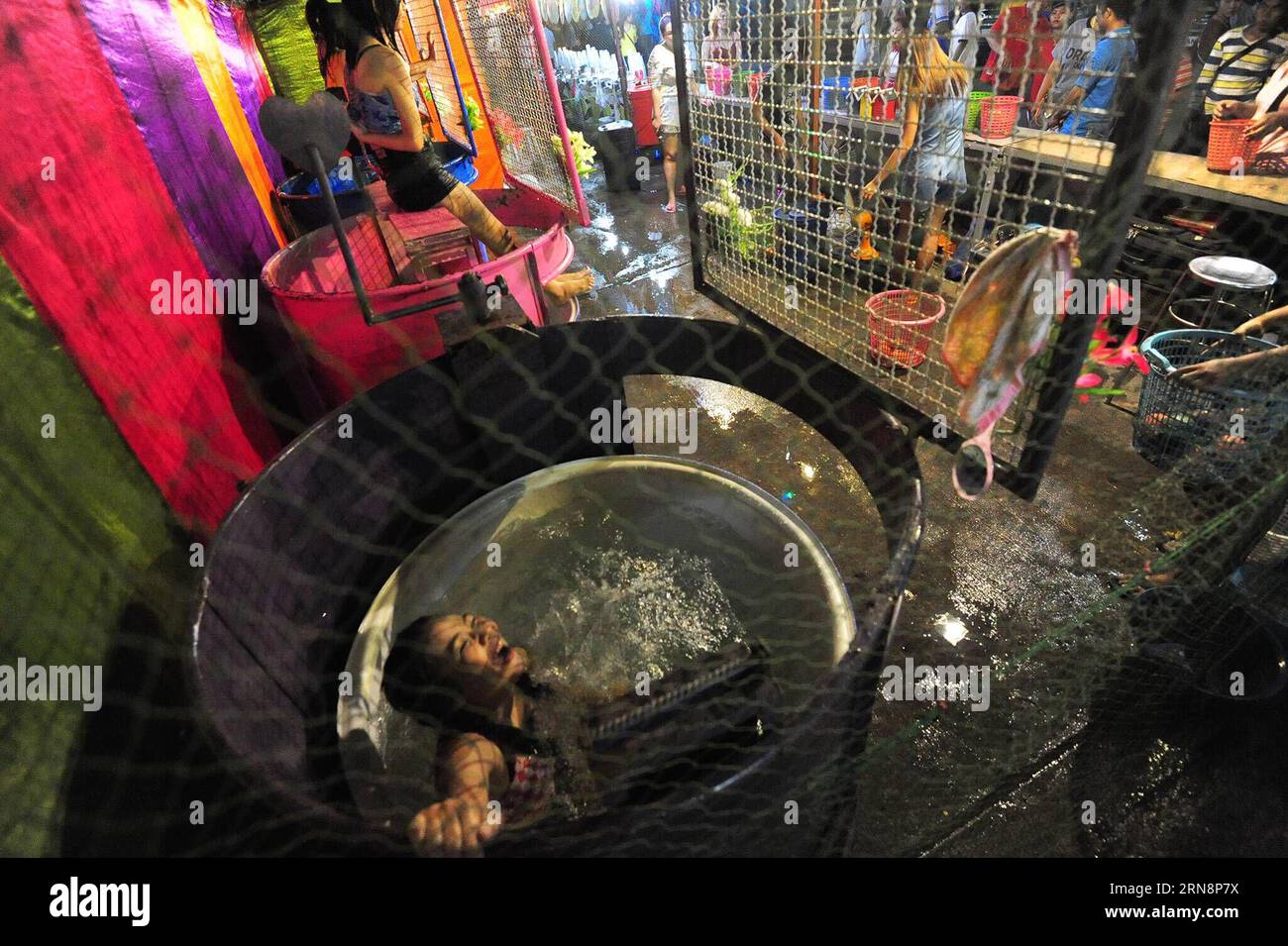 (151101) -- BANGKOK, Nov. 1, 2015 -- A dunk tank girl falls into water ...