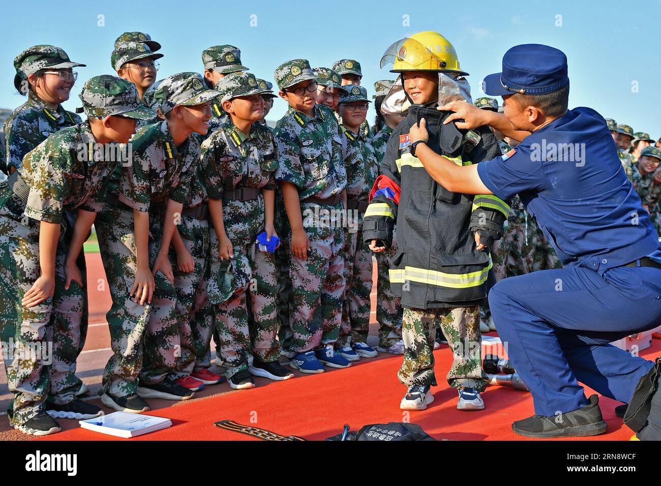 YANTAI, CHINA - AUGUST 31, 2023 - Students experience wearing fire ...
