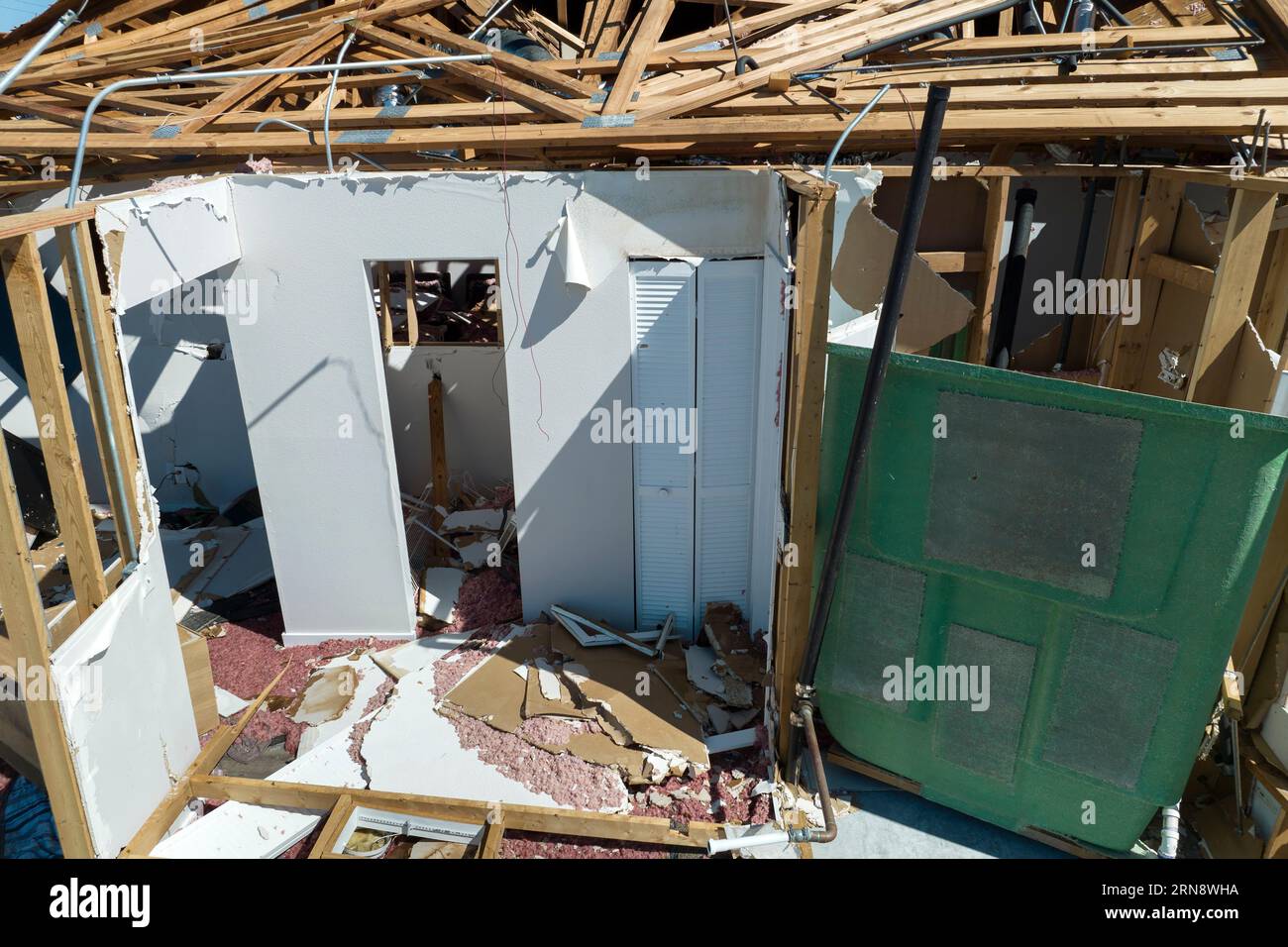 Wind destroyed house roof and walls with missing asphalt shingles after ...