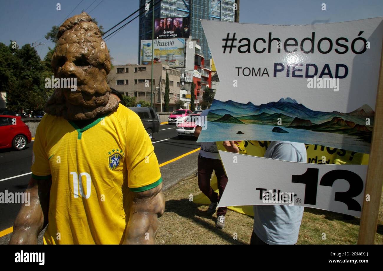 A man wears a disguise while activists of Greenpeace Mexico, along ...