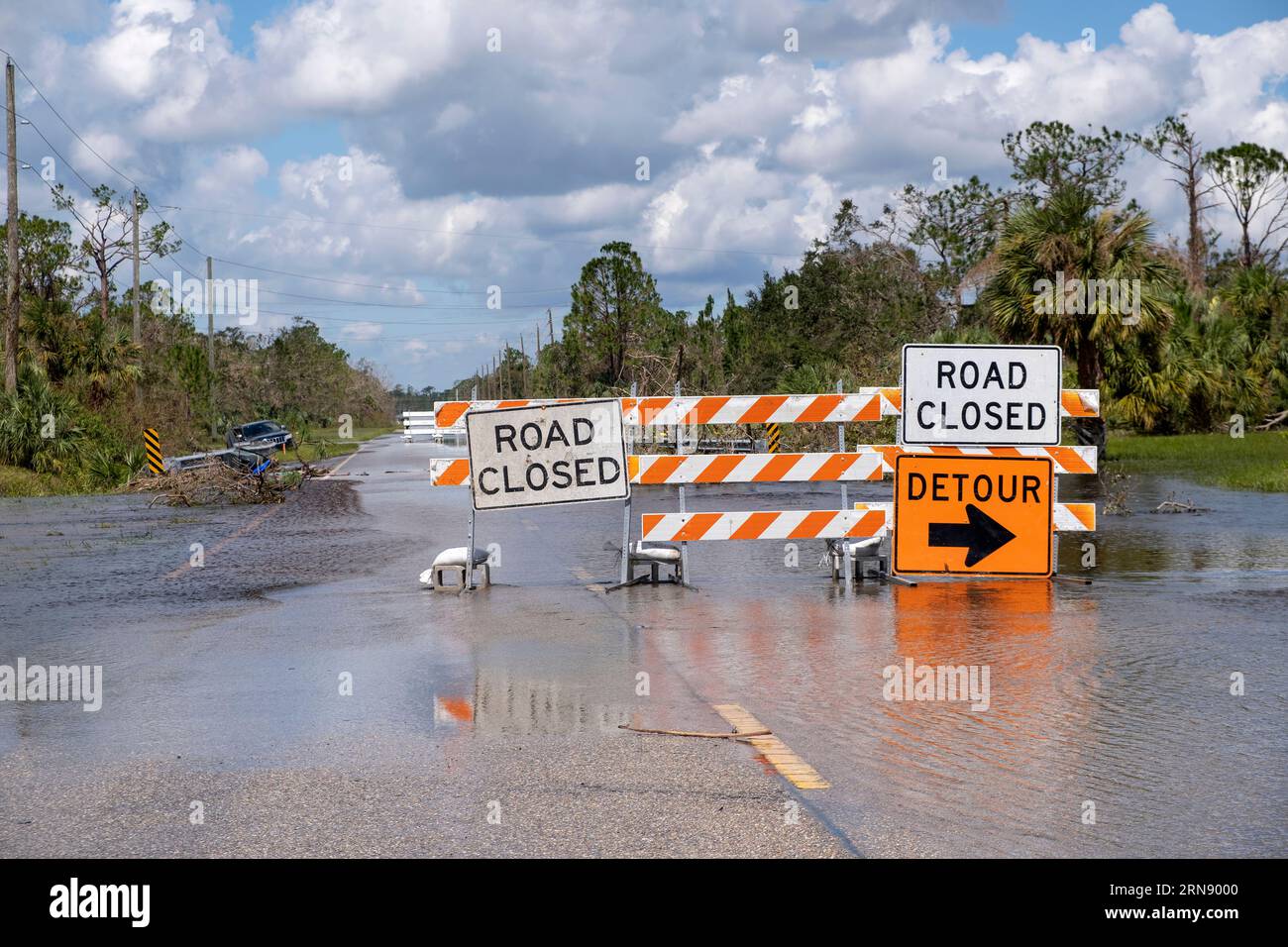 Hurricane flooded street with road closed signs blocking driving of ...