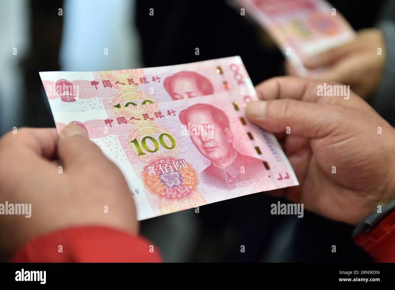 (151112) -- BEIJING, Nov. 12, 2015 -- Residents hold two new 100-yuan ...