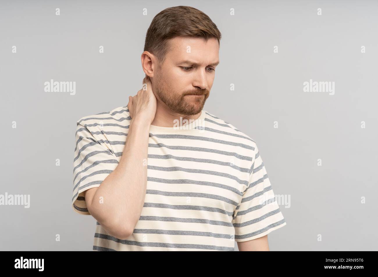 Emotional stressed guy sadly looks down thinking about failure touch ...