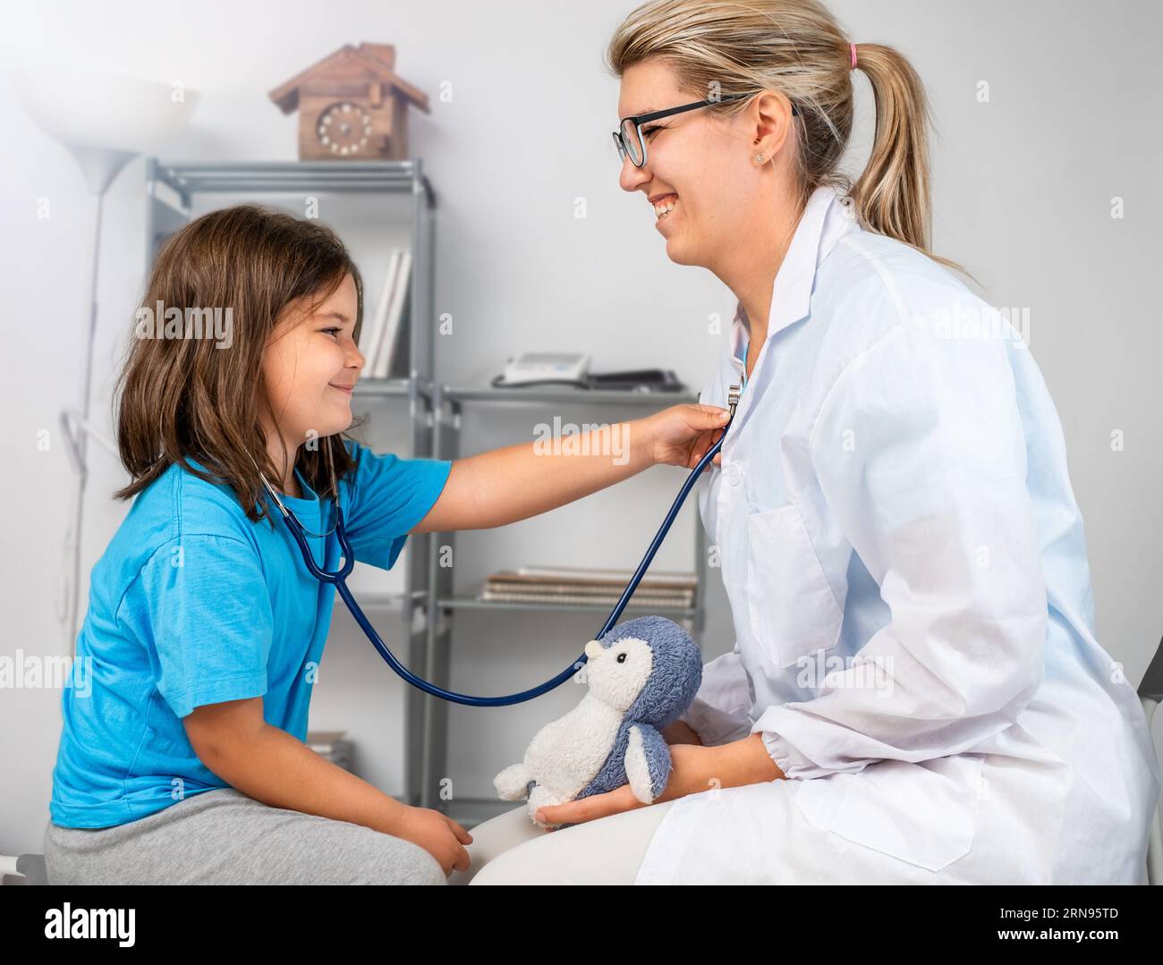 Doctor uses stethoscope hi-res stock photography and images - Alamy