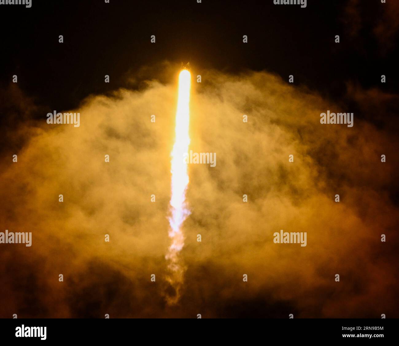 The SpaceX Falcon 9 rocket passes through a low cloud deck as it ...