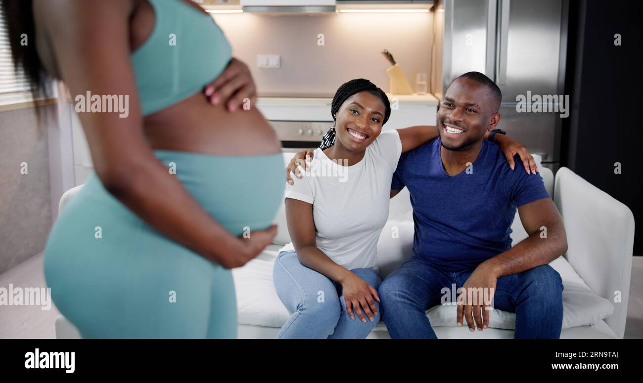Surrogate Mother In Front Of Happy African Couple Stock Photo - Alamy