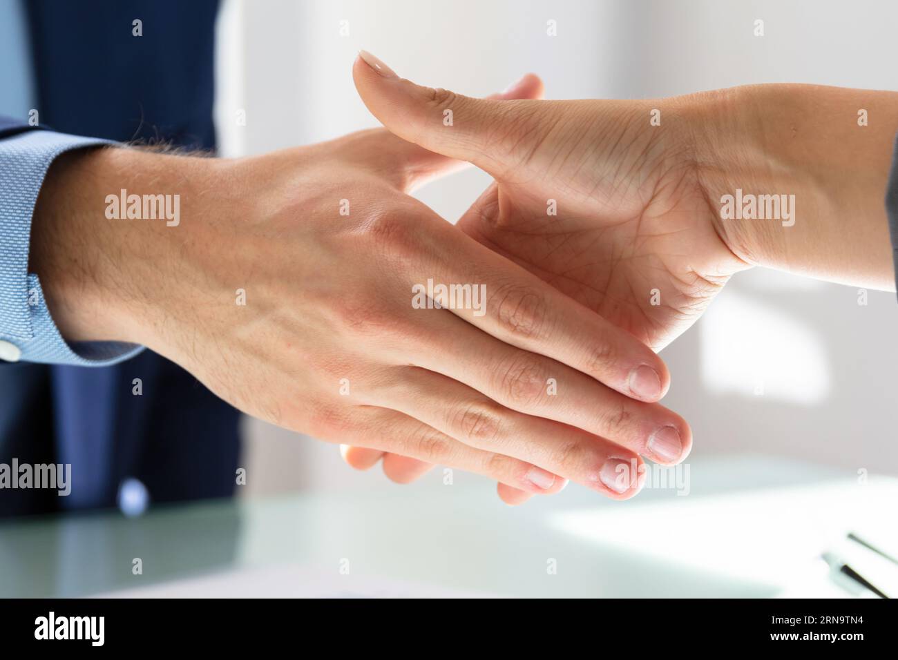 Elevated View Of Businessman Shaking Hands With His Partner Over Desk ...