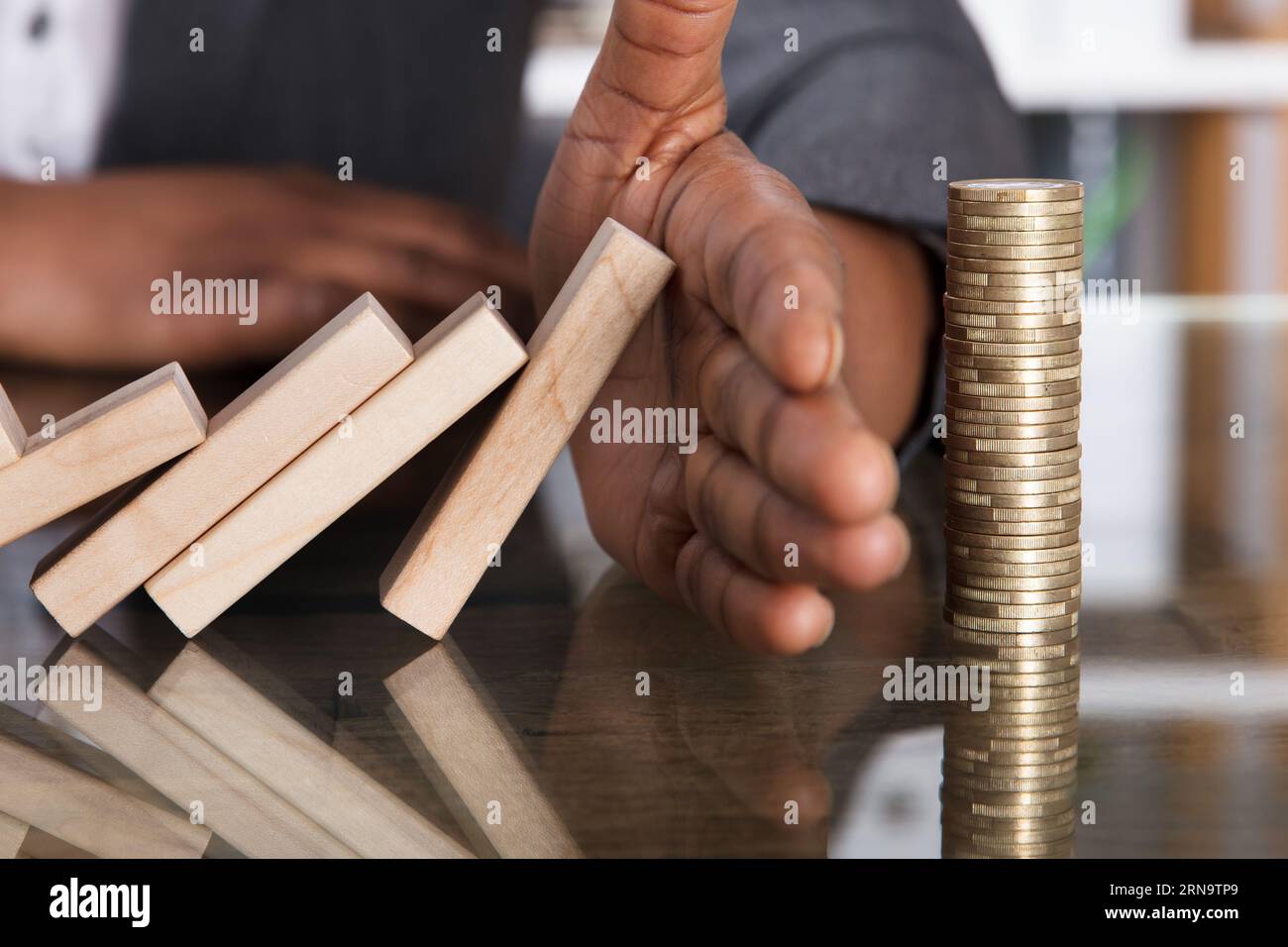Close-up Of A Human Hand Stopping Wooden Blocks From Falling On Stacked ...