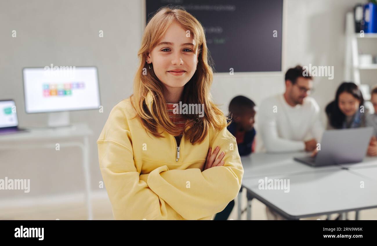 Female student standing in a tech education classroom, looking the ...