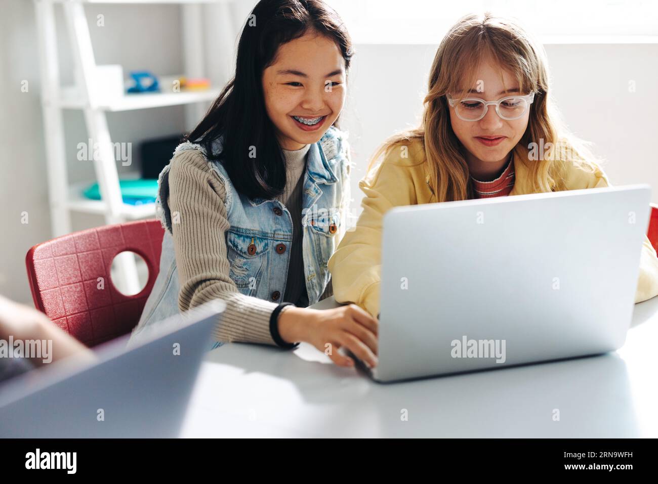 Young girls engaging with each other in a computer-based learning ...