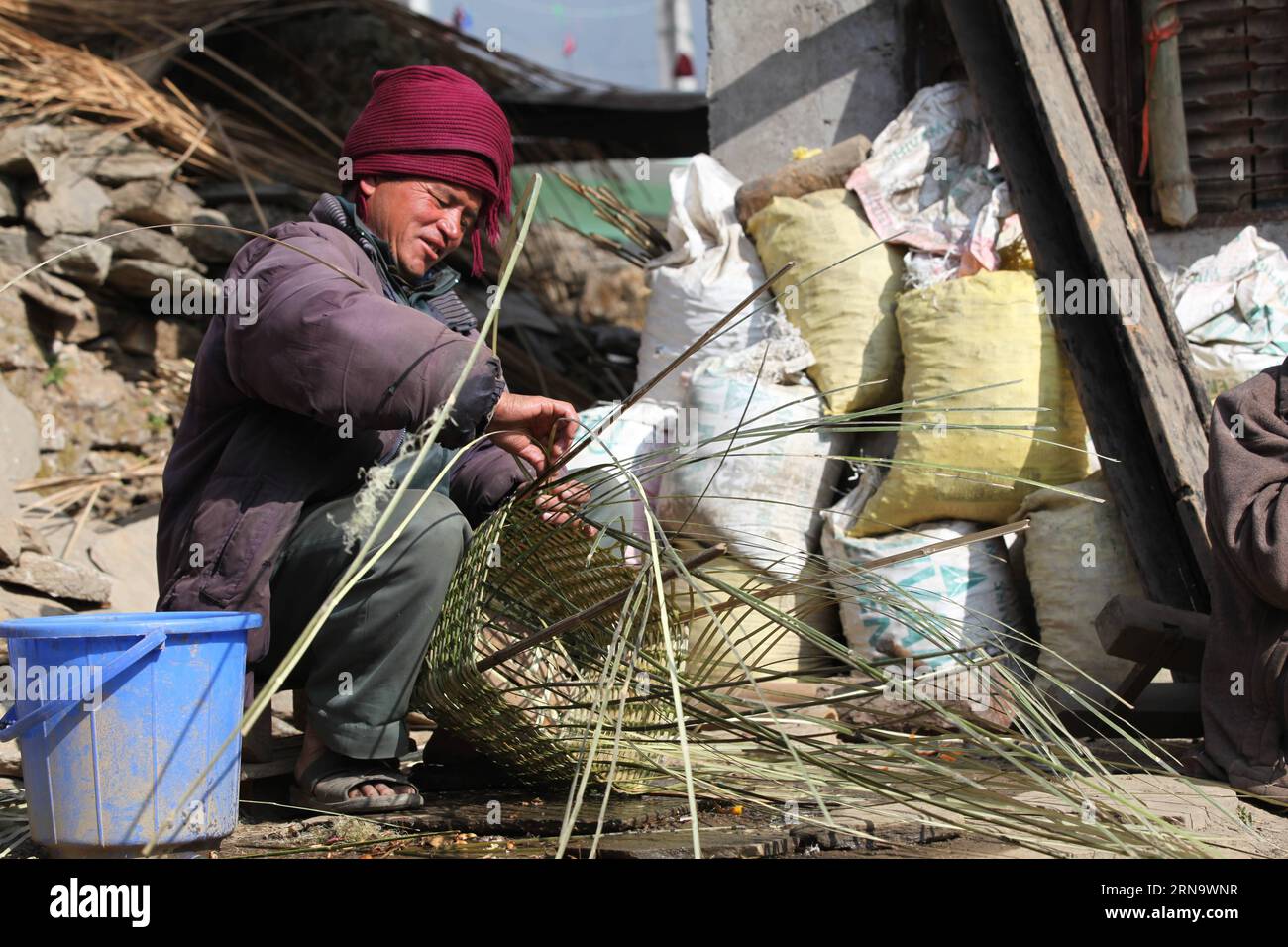 (151222) -- GORKHA, Dec. 22, 2015 -- A local villager makes a Doko , a ...