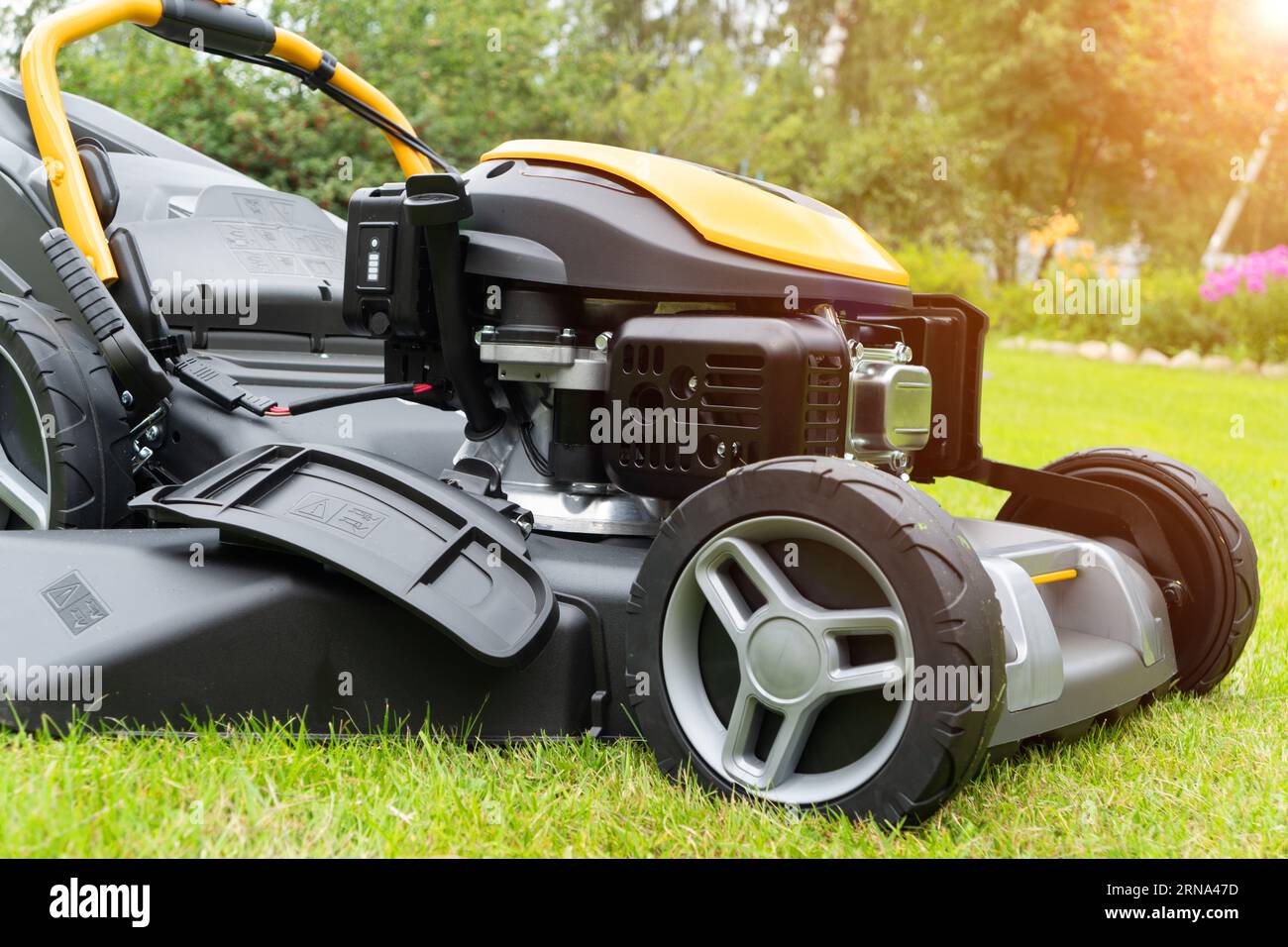 Mowing lawns. Lawn mower on green grass. Mower grass equipment. Mowing ...