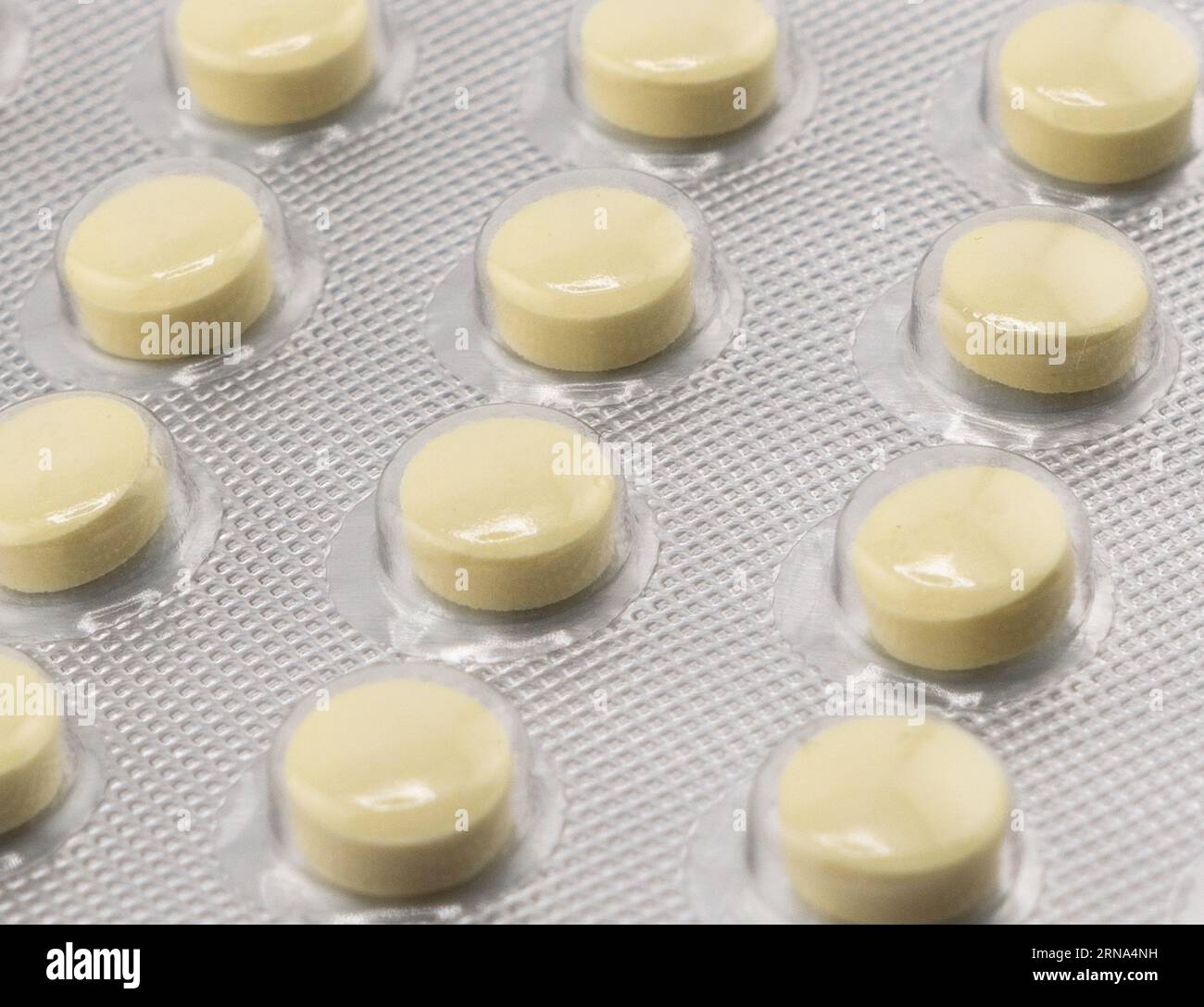 Macro shot pile of tablets pill in silver blister packaging isolated on ...