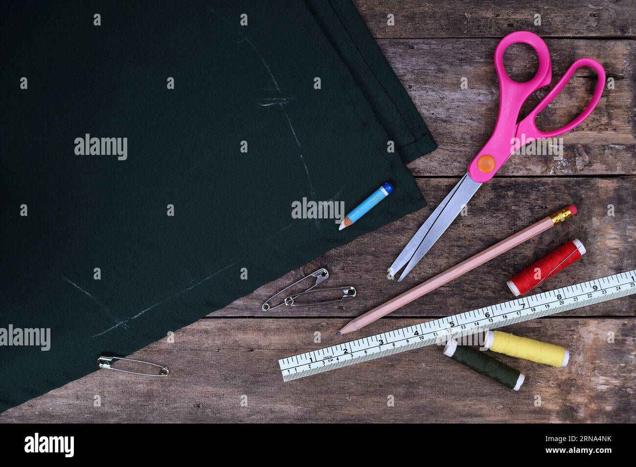 Flat, top view of a Sewing and Tailoring background with dark green ...
