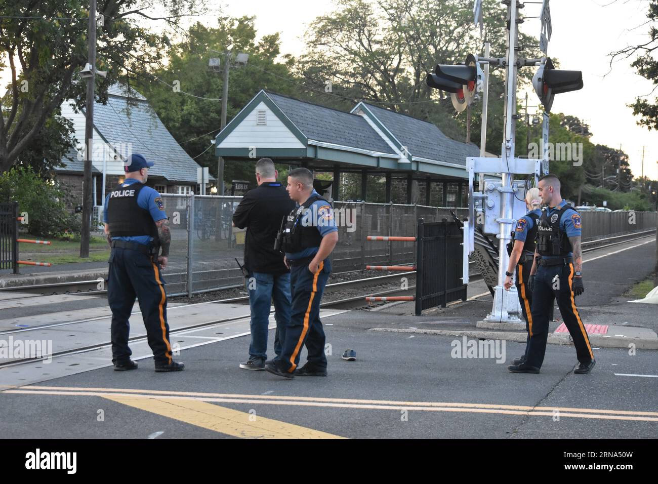 Police officers investigate the crime scene and search for evidence ...