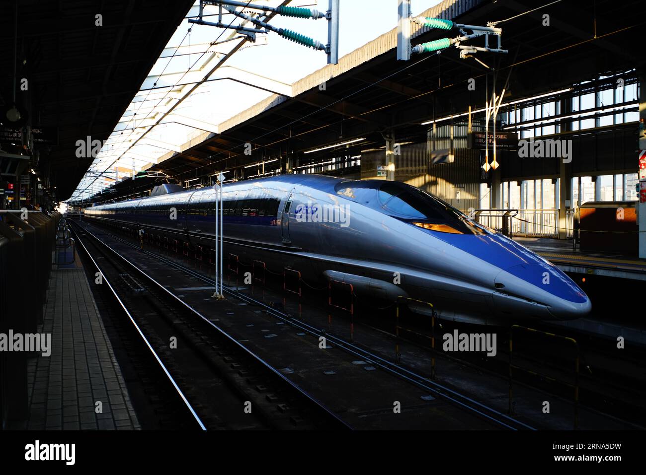 A scenic view of a blue Japanese high-speed train, the Shinkansen ...