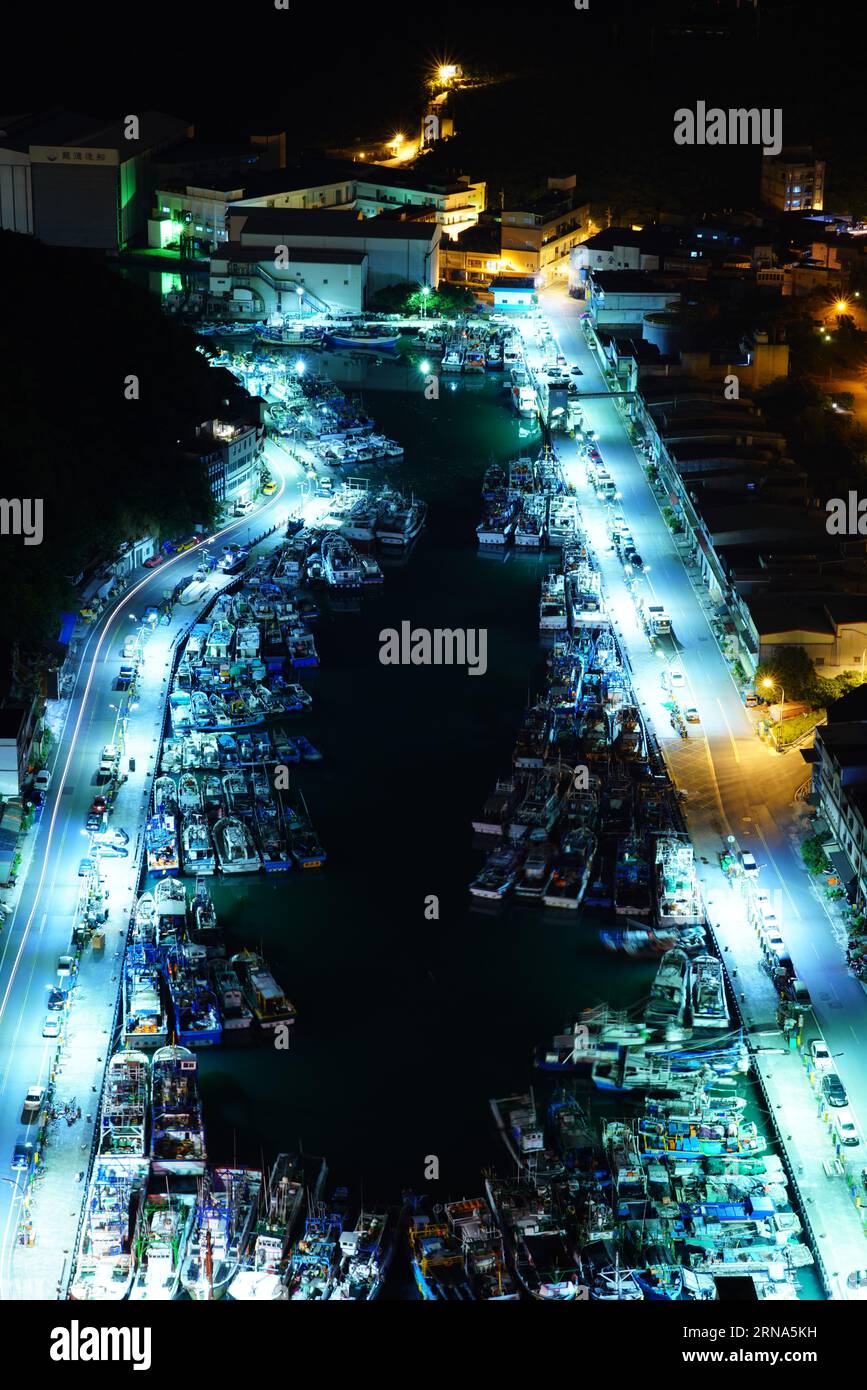 An aerial view of a Taiwanese fishing port at night, illuminated by the ...