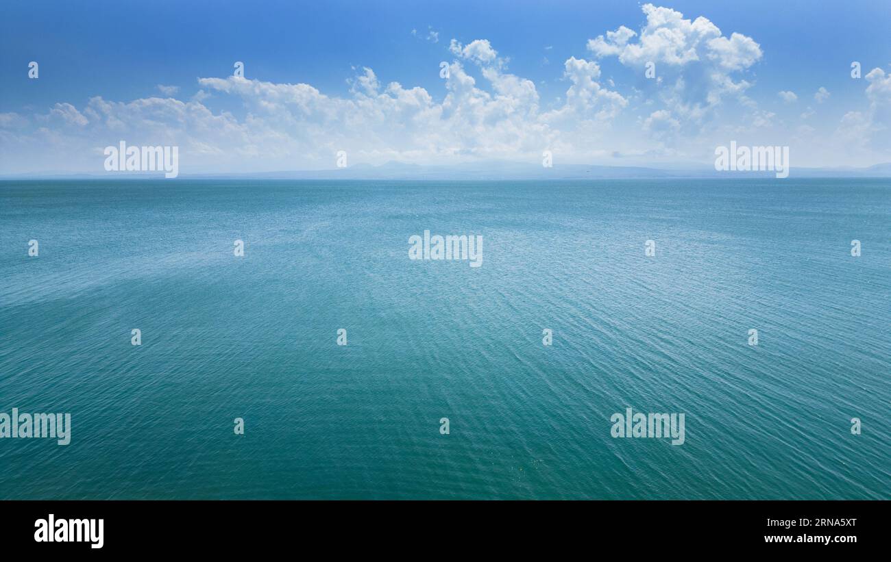 Aerial view of a blue sea water background and sun reflections. Aerial ...