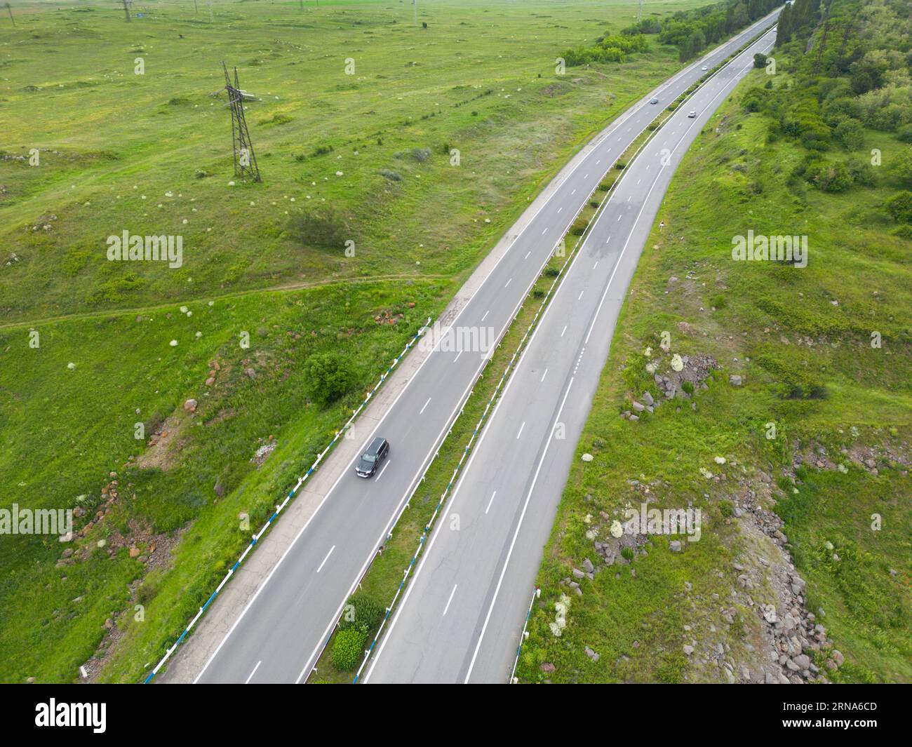 Aerial view of highway with car. Aerial view of a country road with ...