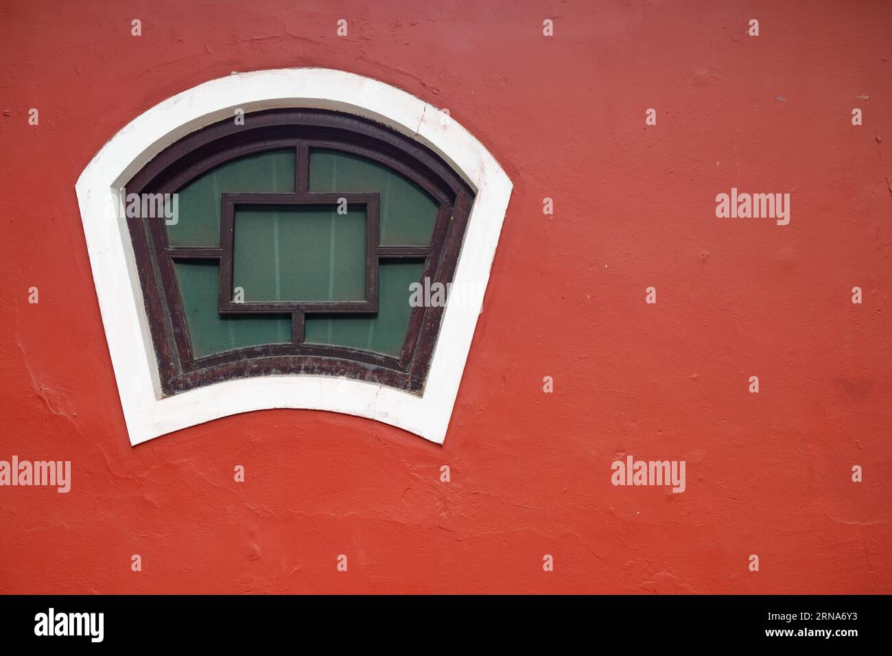 fan shape window on a red wall Stock Photo - Alamy