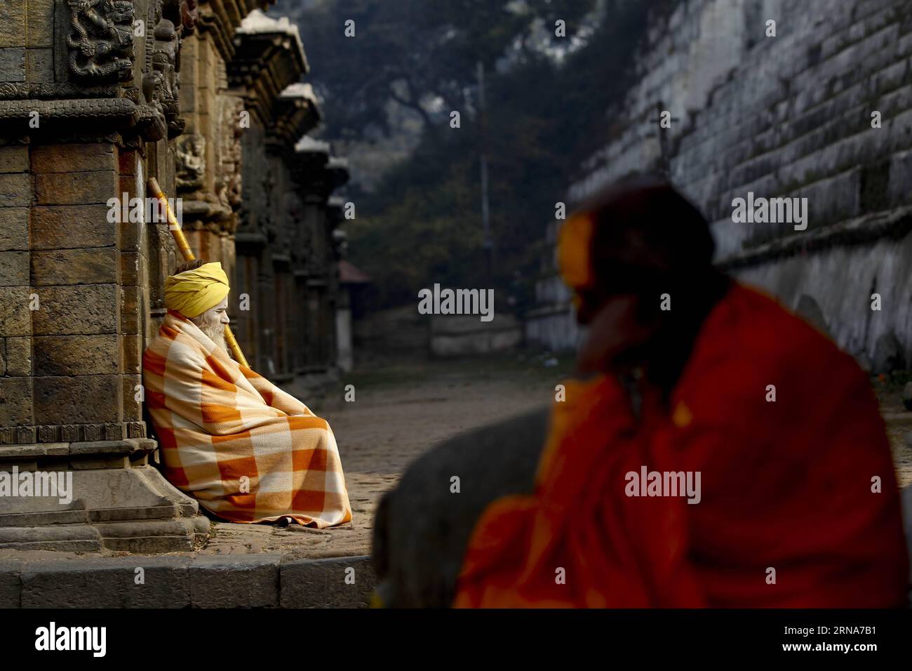 A Sadhu enjoys basking at the Pashupatinath Temple at Kathmandu, Nepal ...