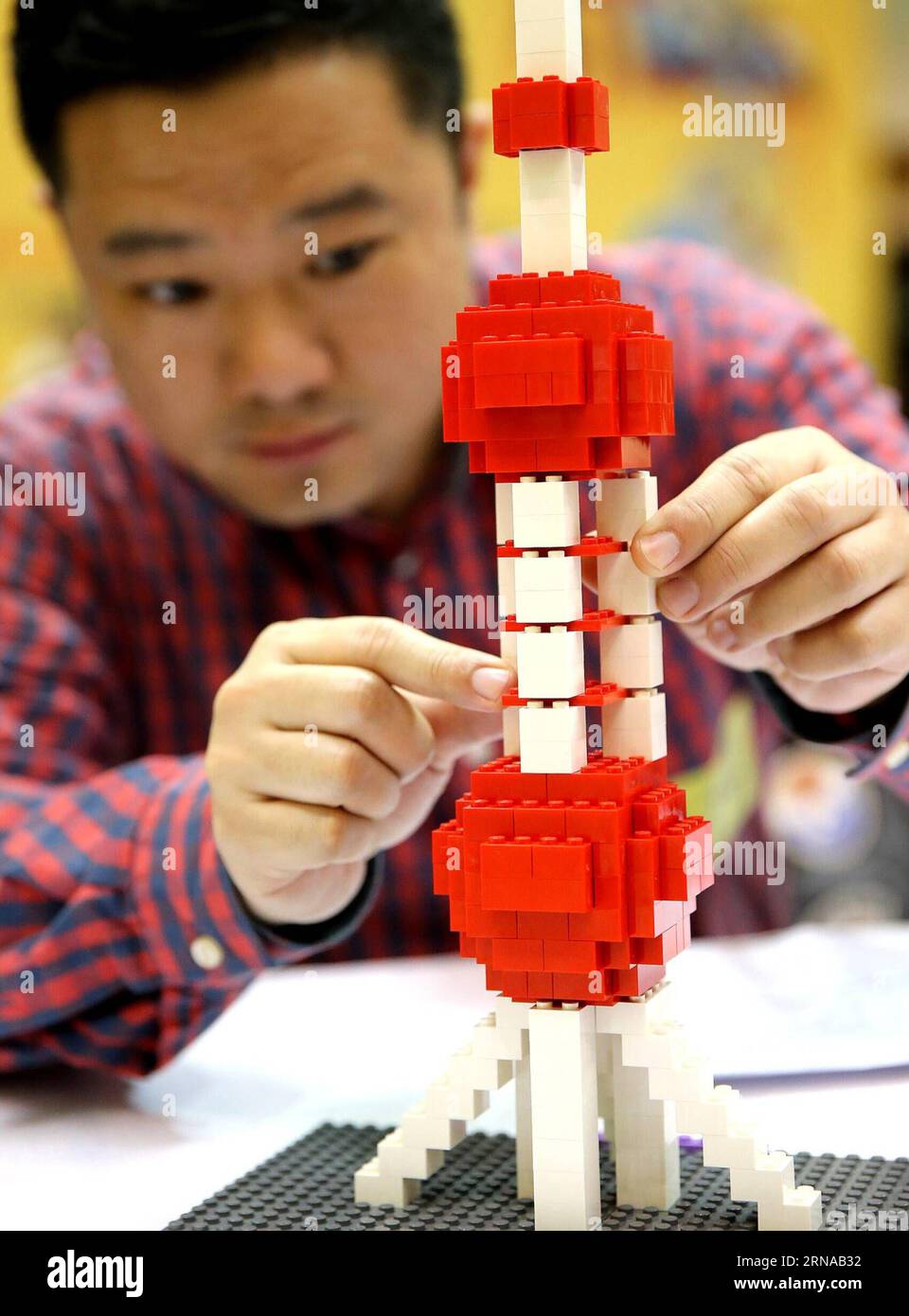 A participant builds a model of the Oriental Pearl Tower, a landmark of ...