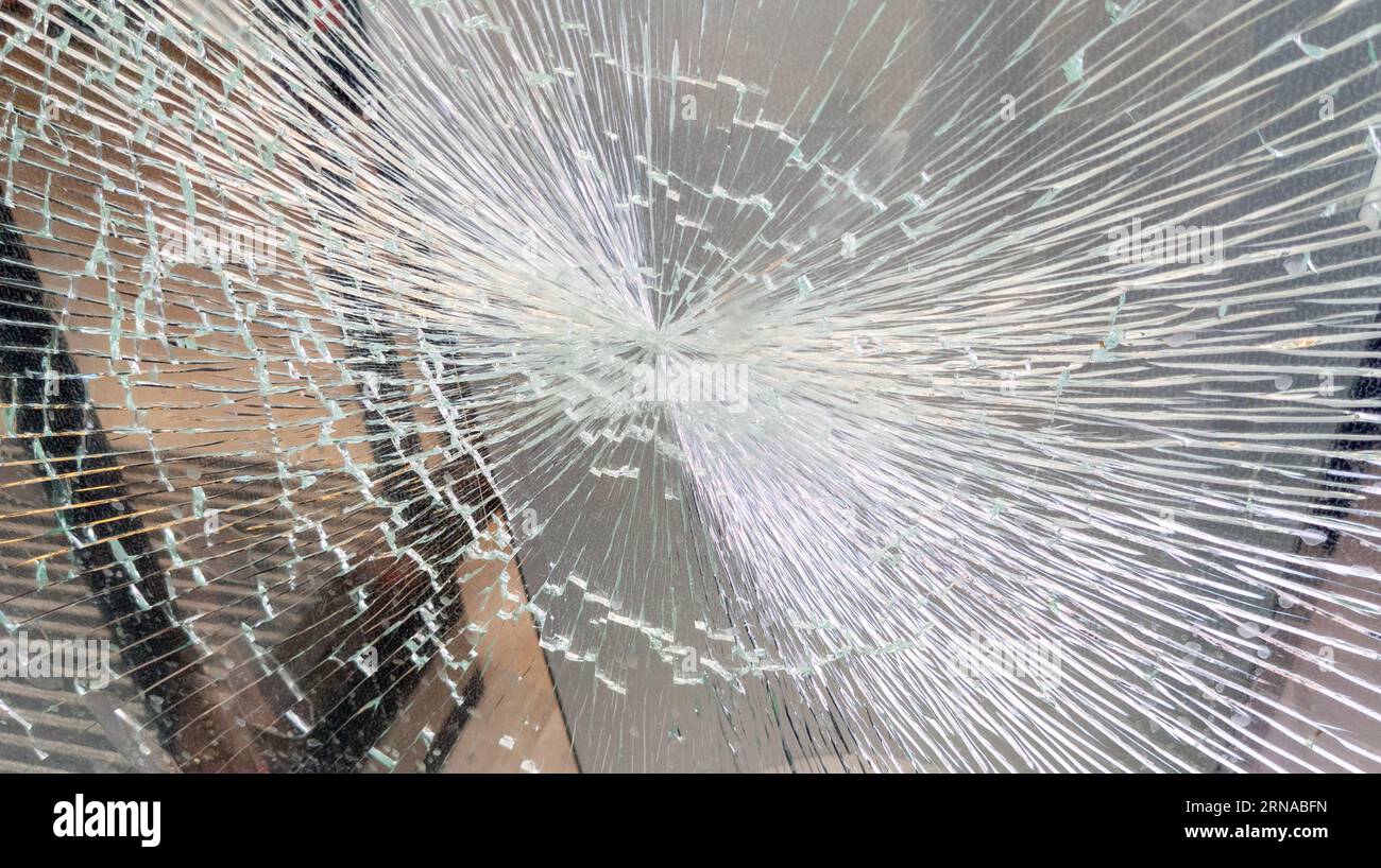 Broken shop impact on the broken glass on the facade of the store by a ...