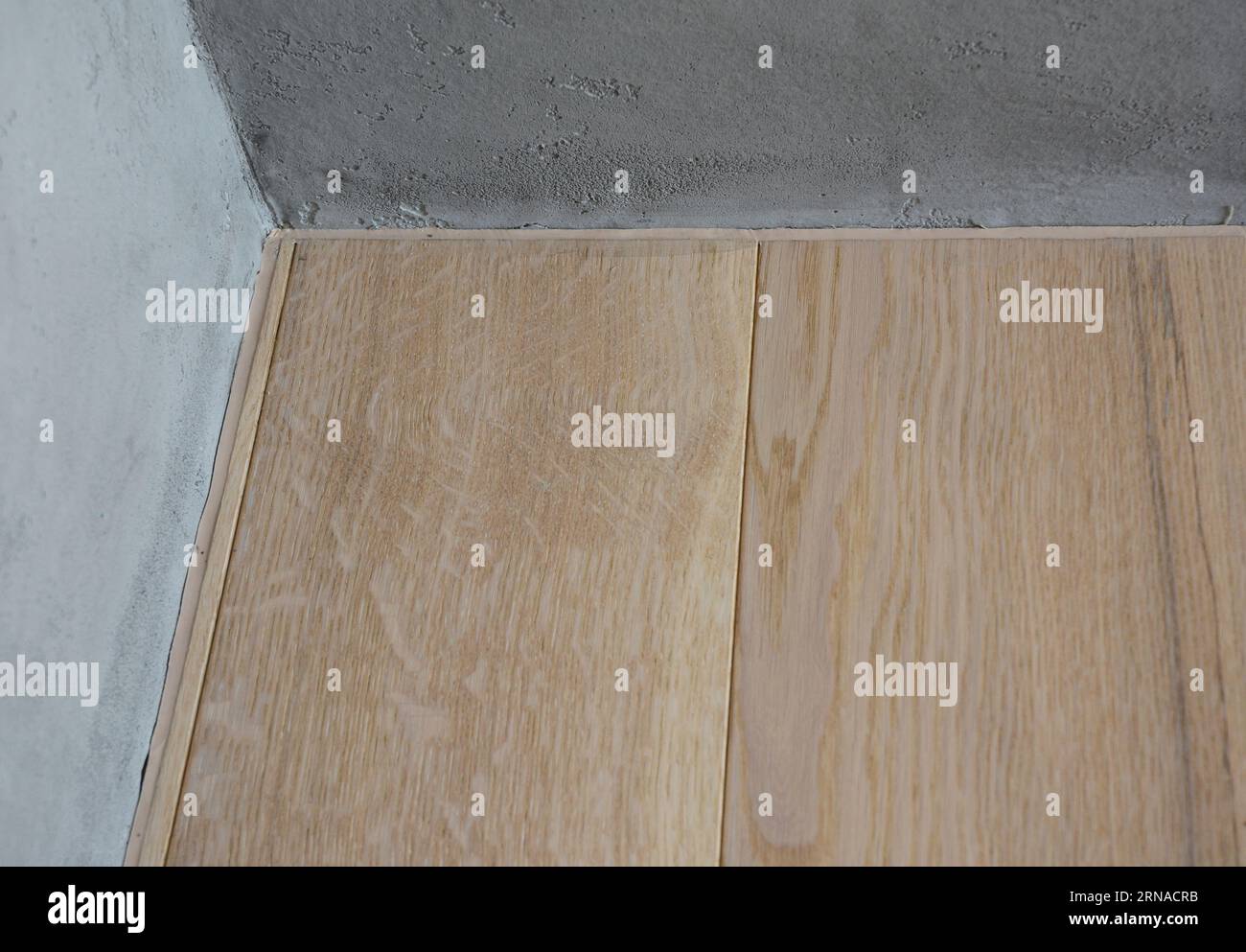 Close up on thin solid wooden skirting boards. Natural wooden floor ...