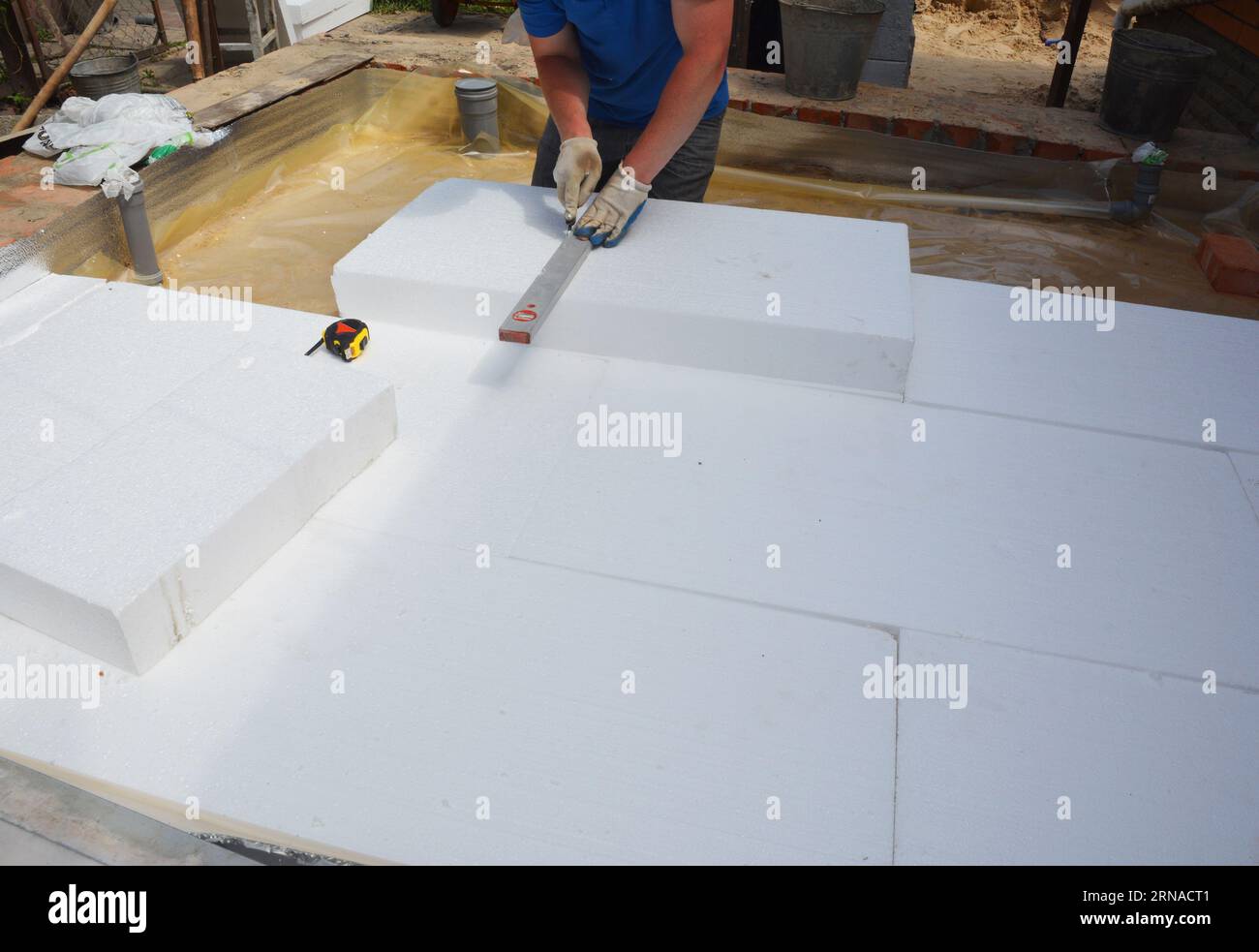 Builder insulating house foundation floor with rigid foam board ...