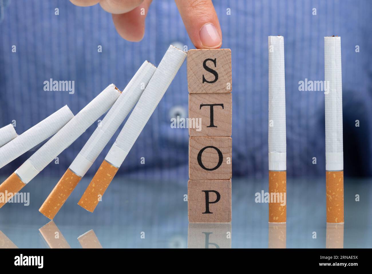 Woman Stopping Cigarette From Falling On Desk With Wooden Blocks Stock ...