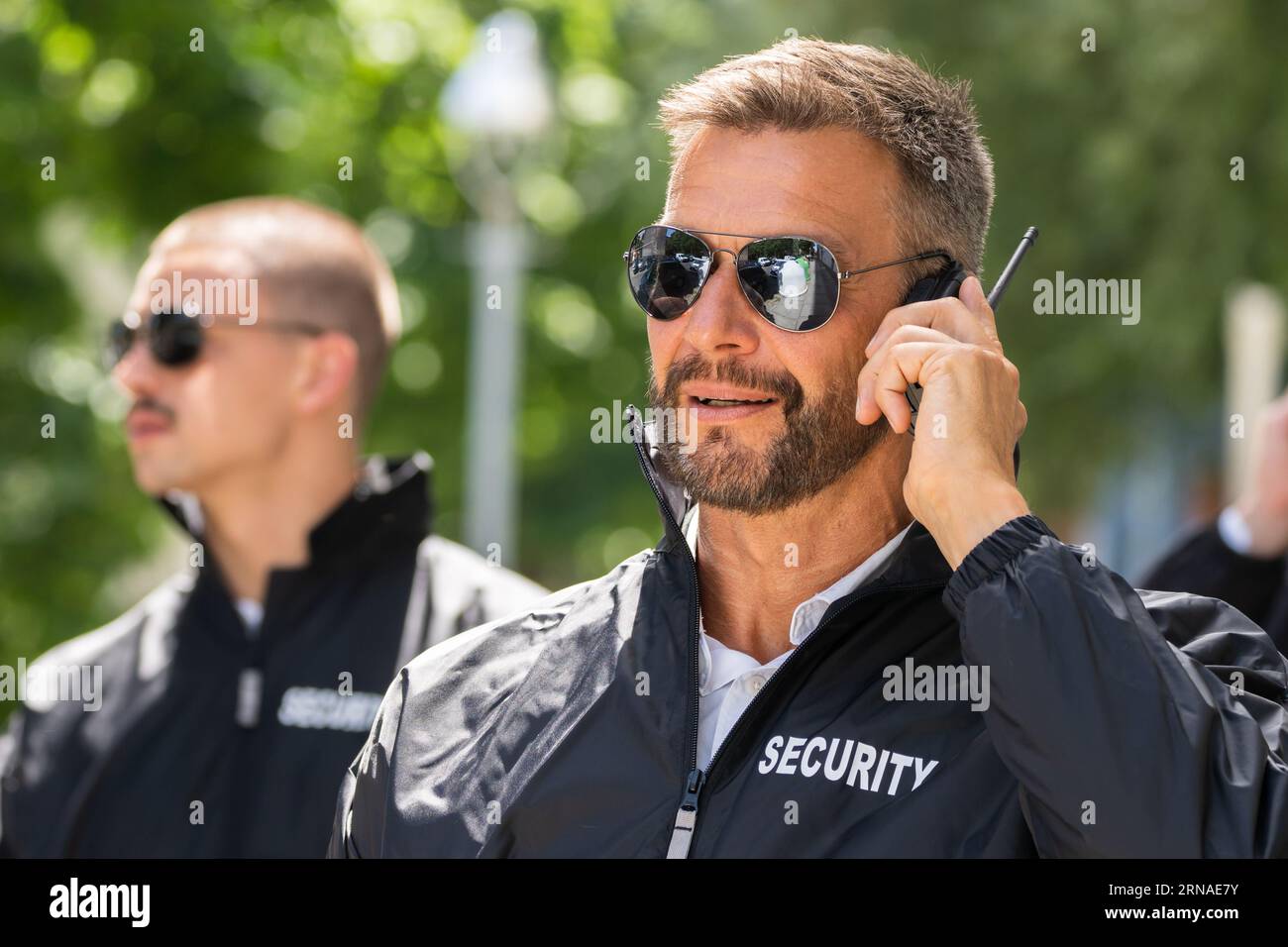 Security Guard Event Service. Officer And His Group Stock Photo - Alamy