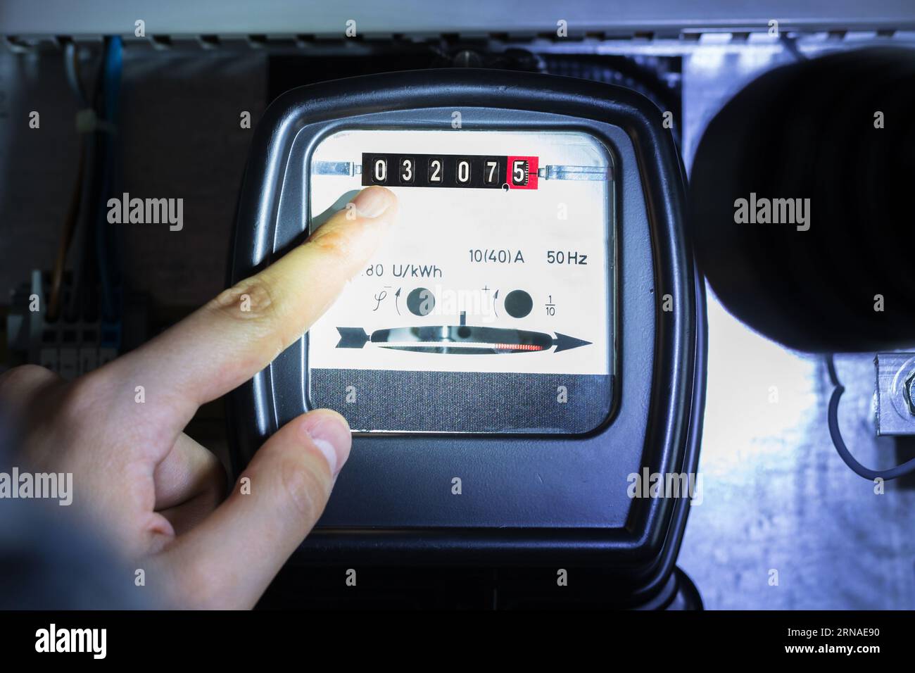 Person's Finger Pointing To Electric Meter Reading Using Flash Light ...